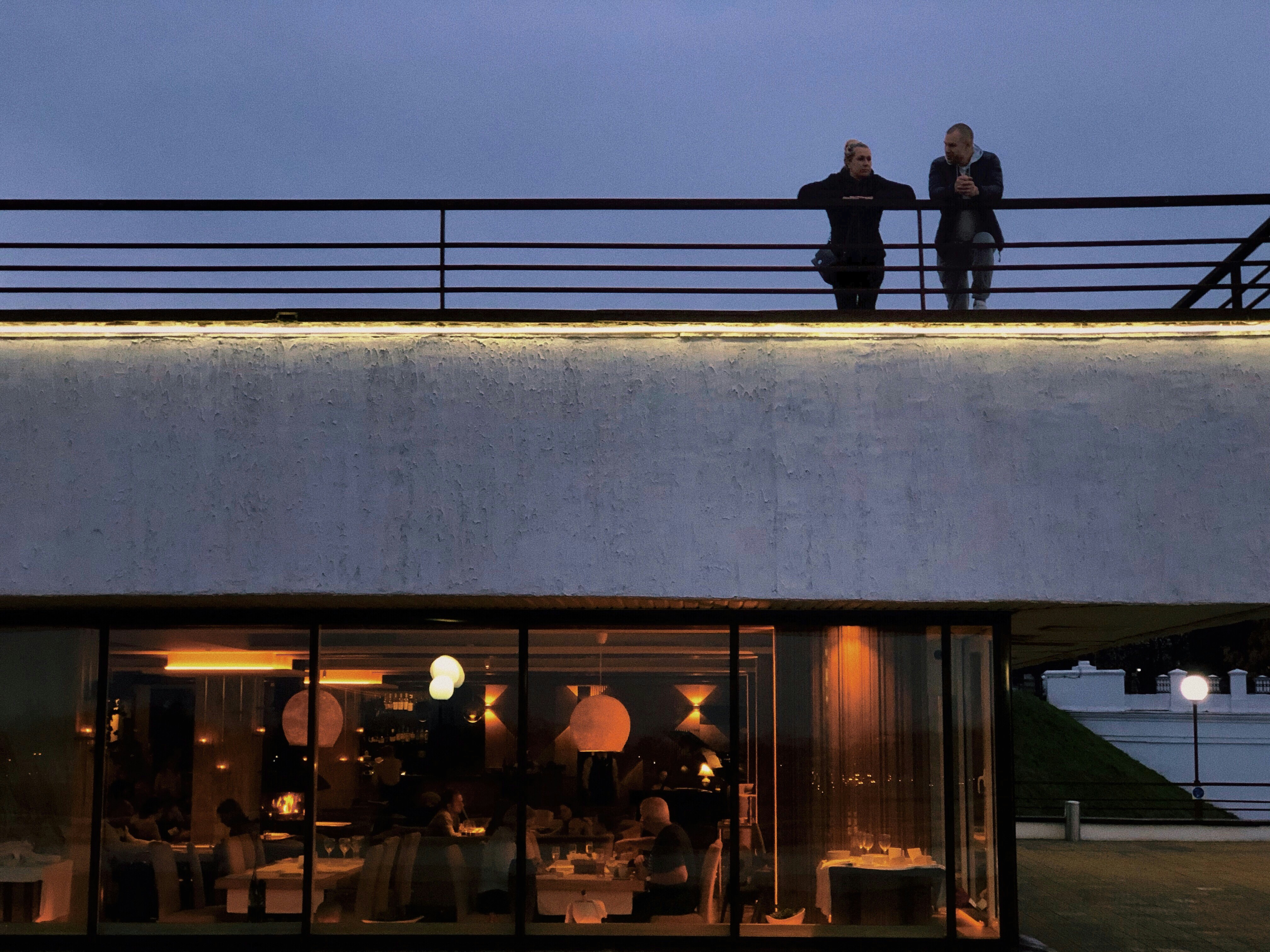 Man and woman leaning on guardrail photo – Free Grey Image on Unsplash