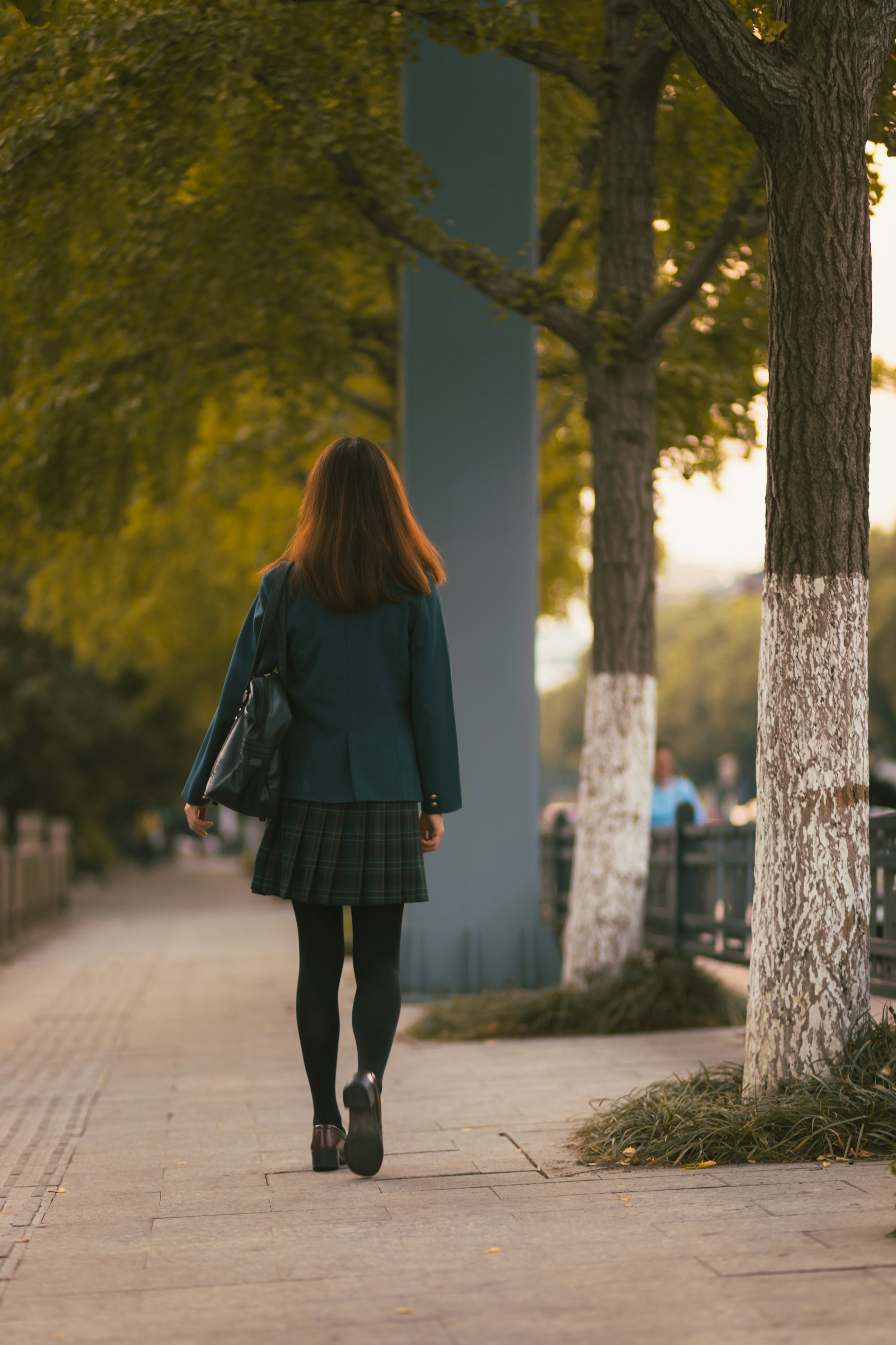 Woman walking on sidewalk beside trees photo – Free Clothing Image on ...