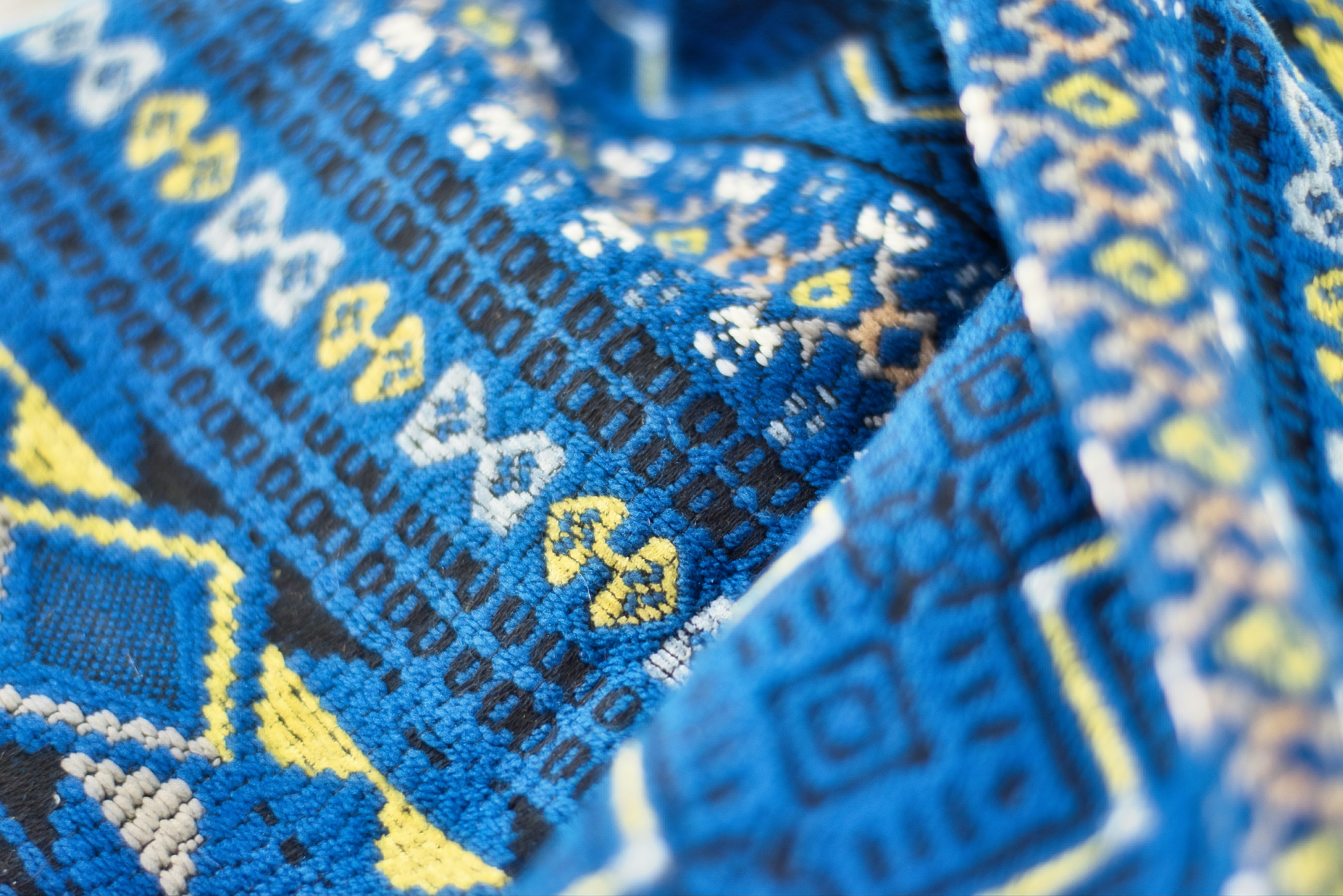Blue woven pattern in motion: a macro study of geometric textile details