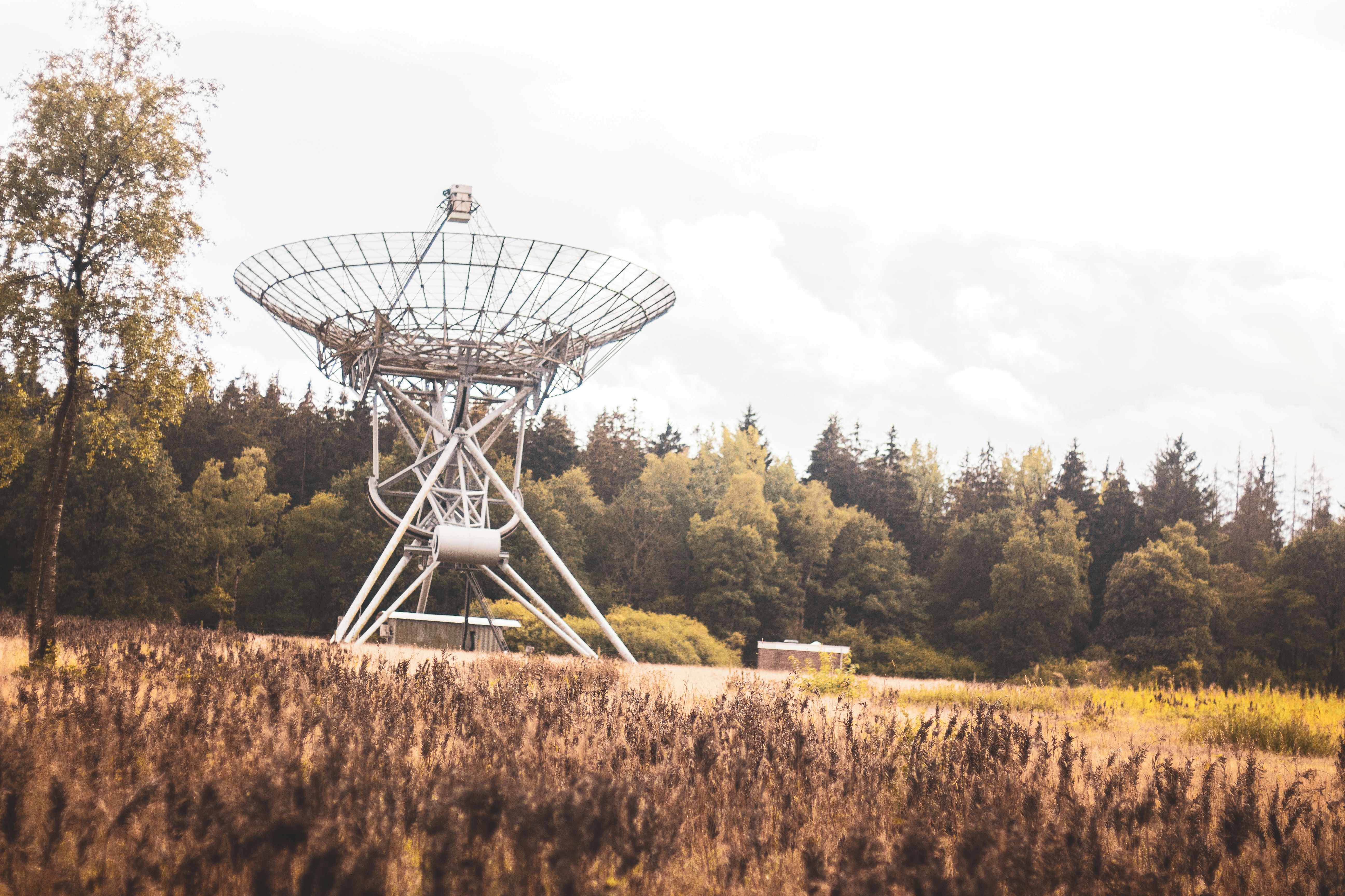 Dusk Signals: A Satellite Dish Emerges from the Golden Field
