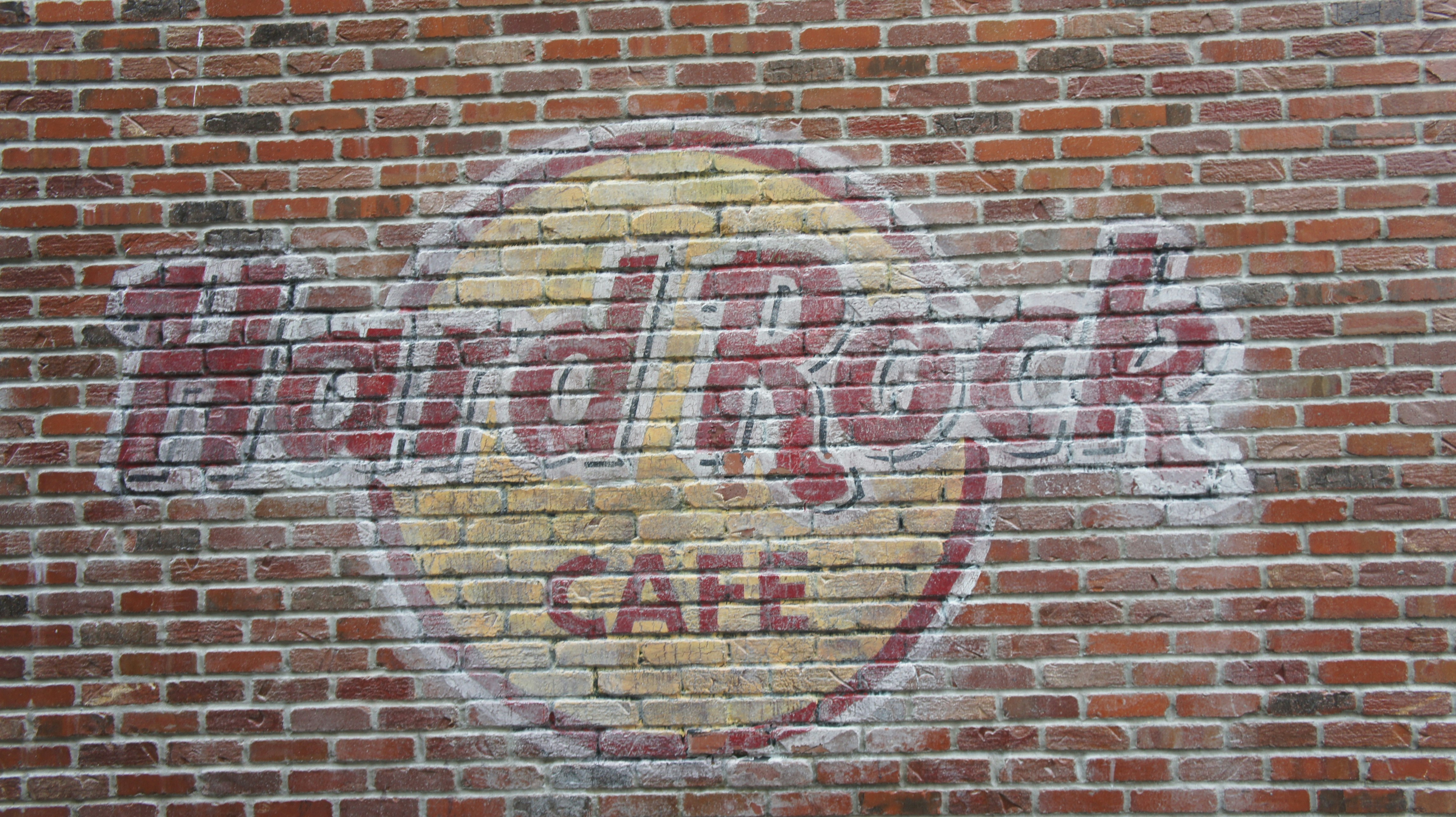 Faded Echo of Rock: The Brick-Walled Hard Rock Café Emblem