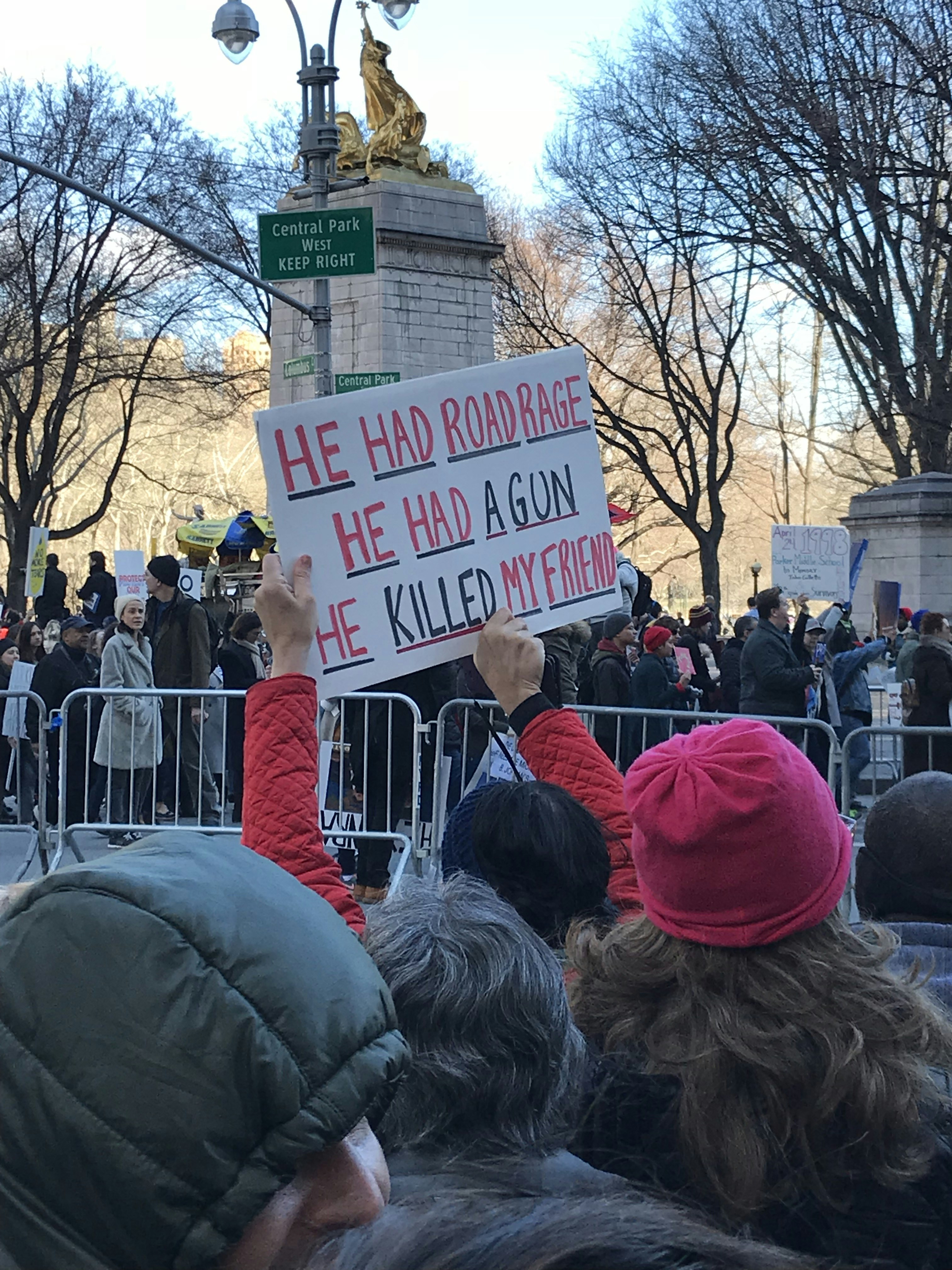 Sign Held High: A Protest Crowd at the City Monument