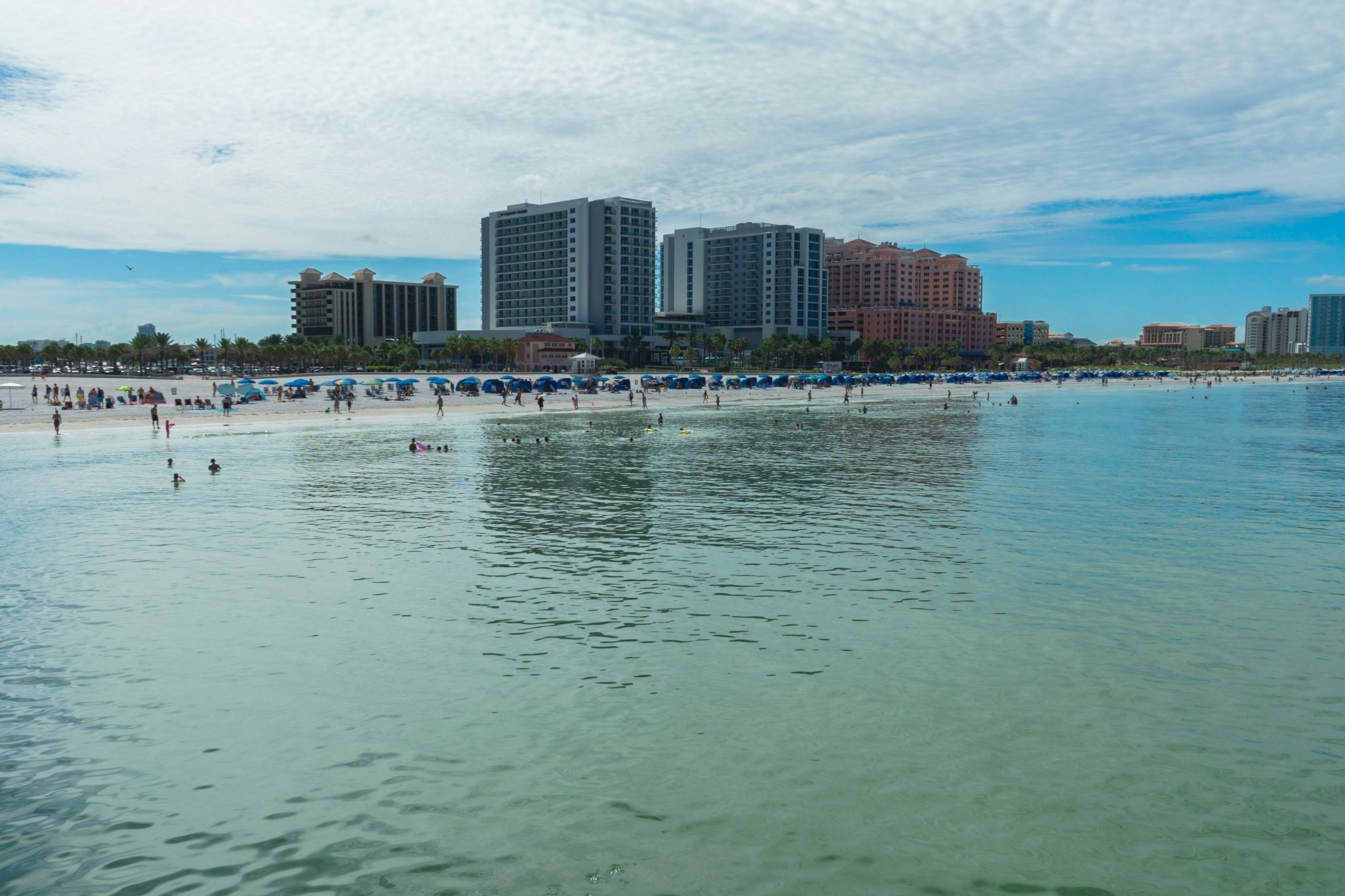 Buildings near ocean under cloudy sky photo – Free Grey Image on Unsplash
