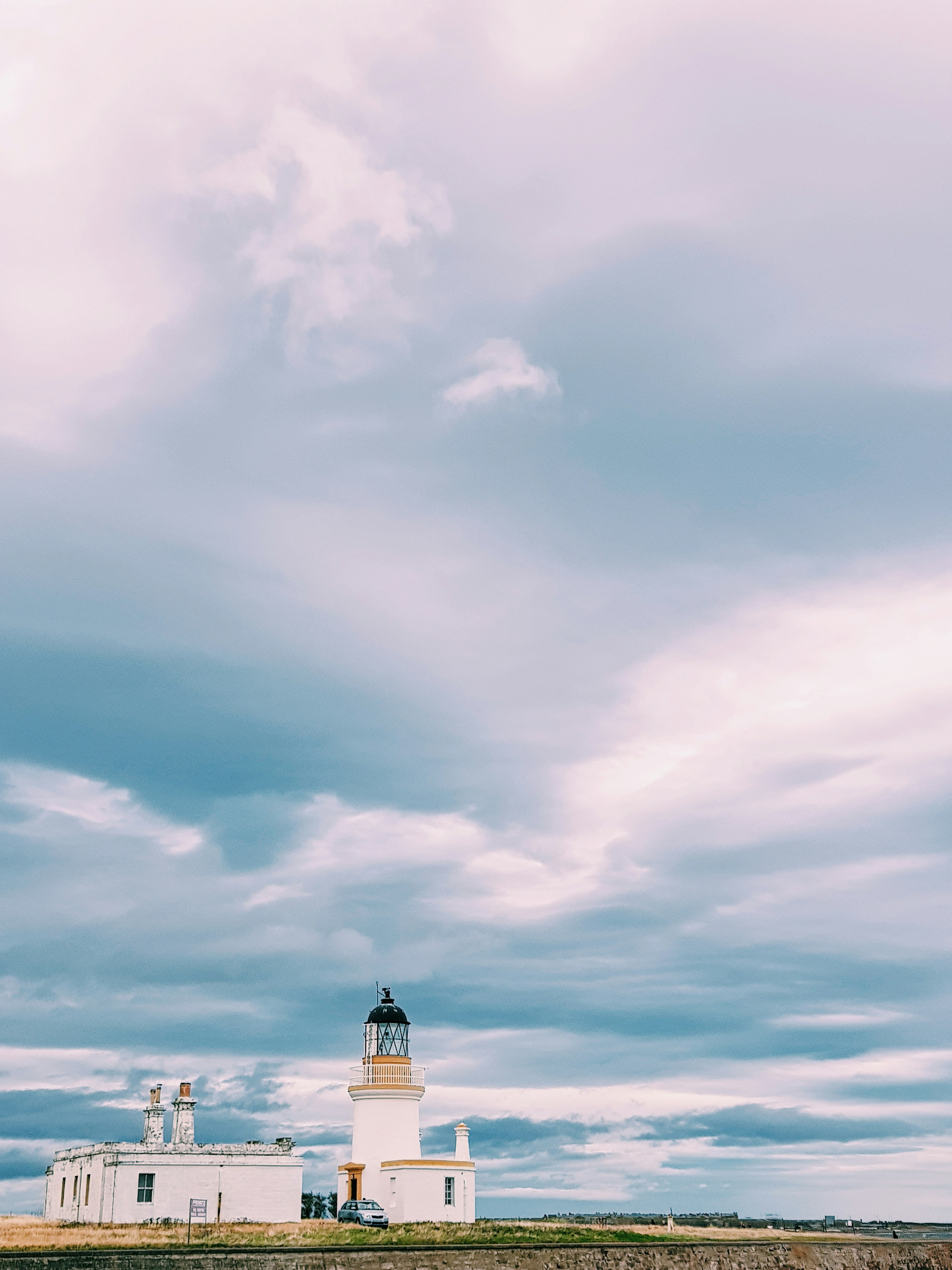 Beacon at the Edge: Lighthouse Against a Velvet Coastal Sky