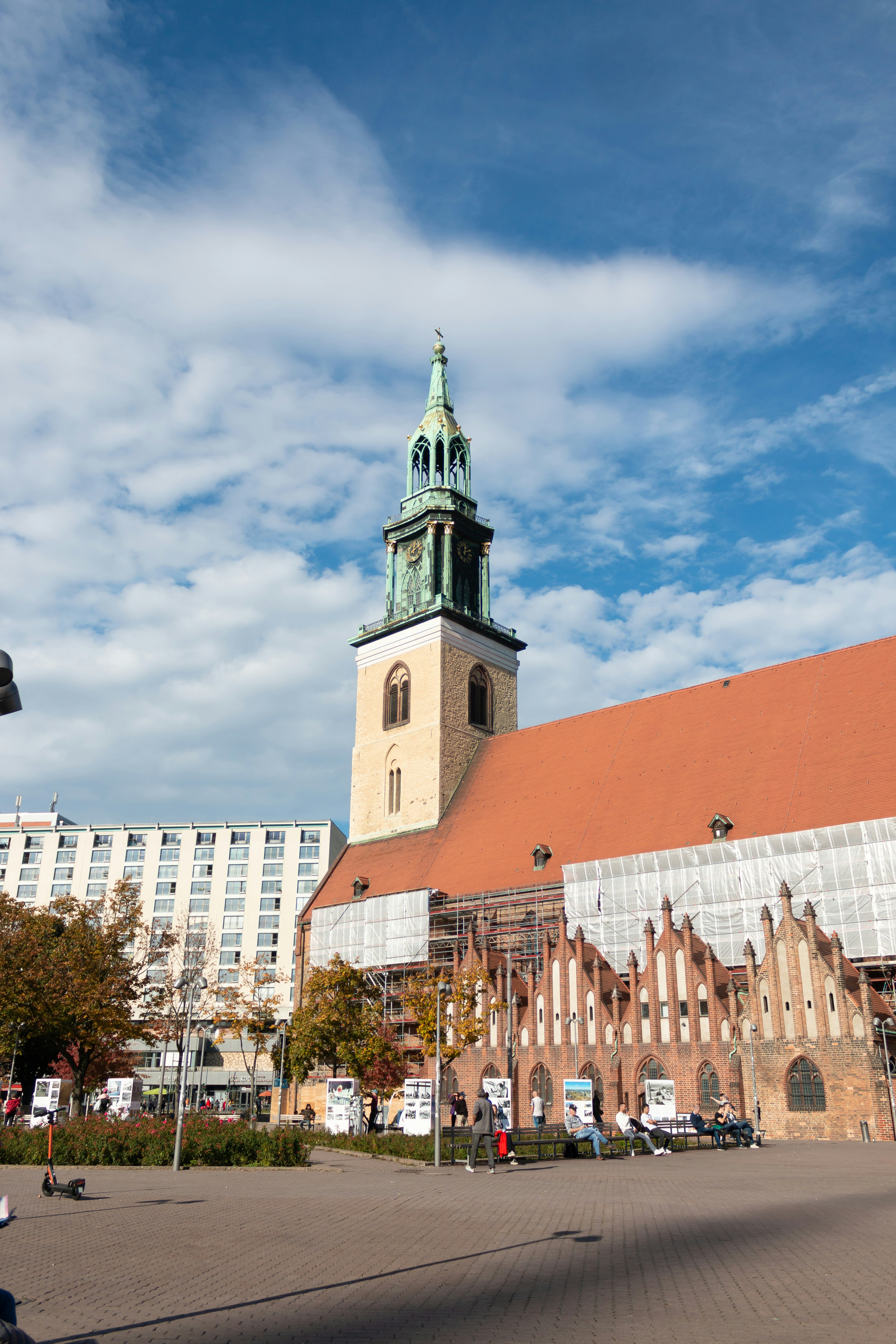 Copper Spire Over a Red-Tiled Town Square on a Clear Day