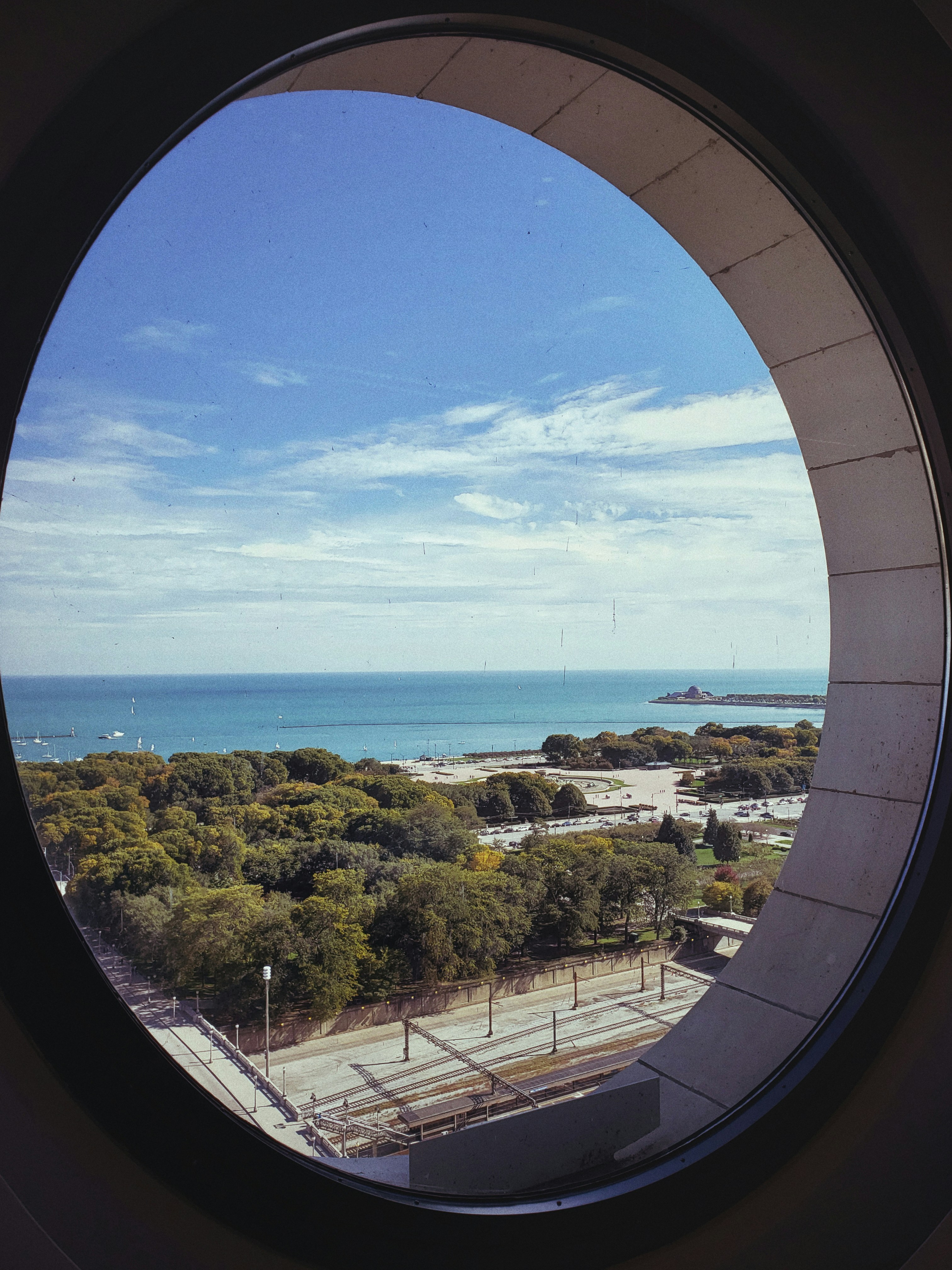 Round window overlooking trees and ocean photo – Free Blue Image on ...