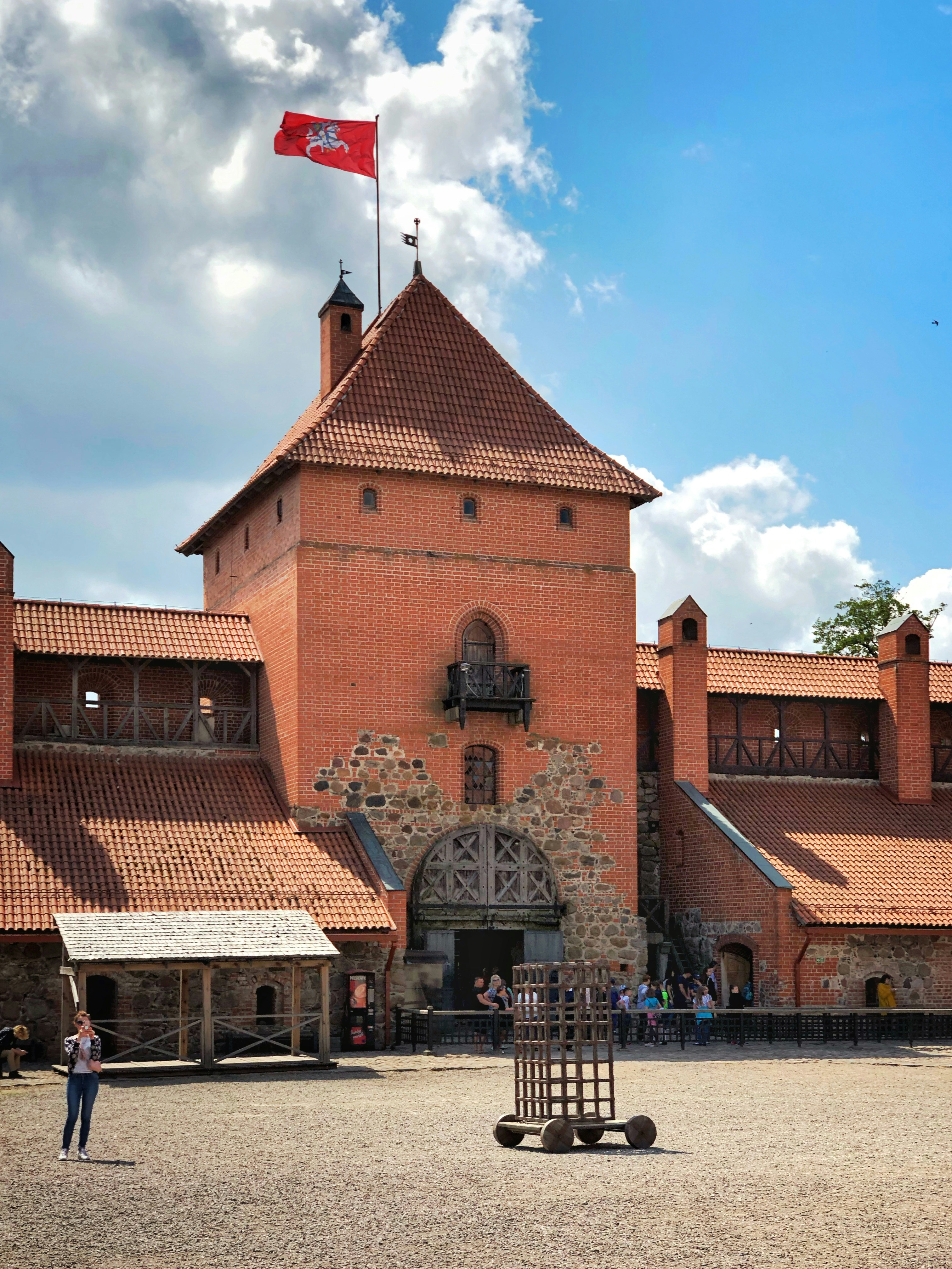 Flag Above the Red Brick Bastion: Sunlit Fortress Courtyard