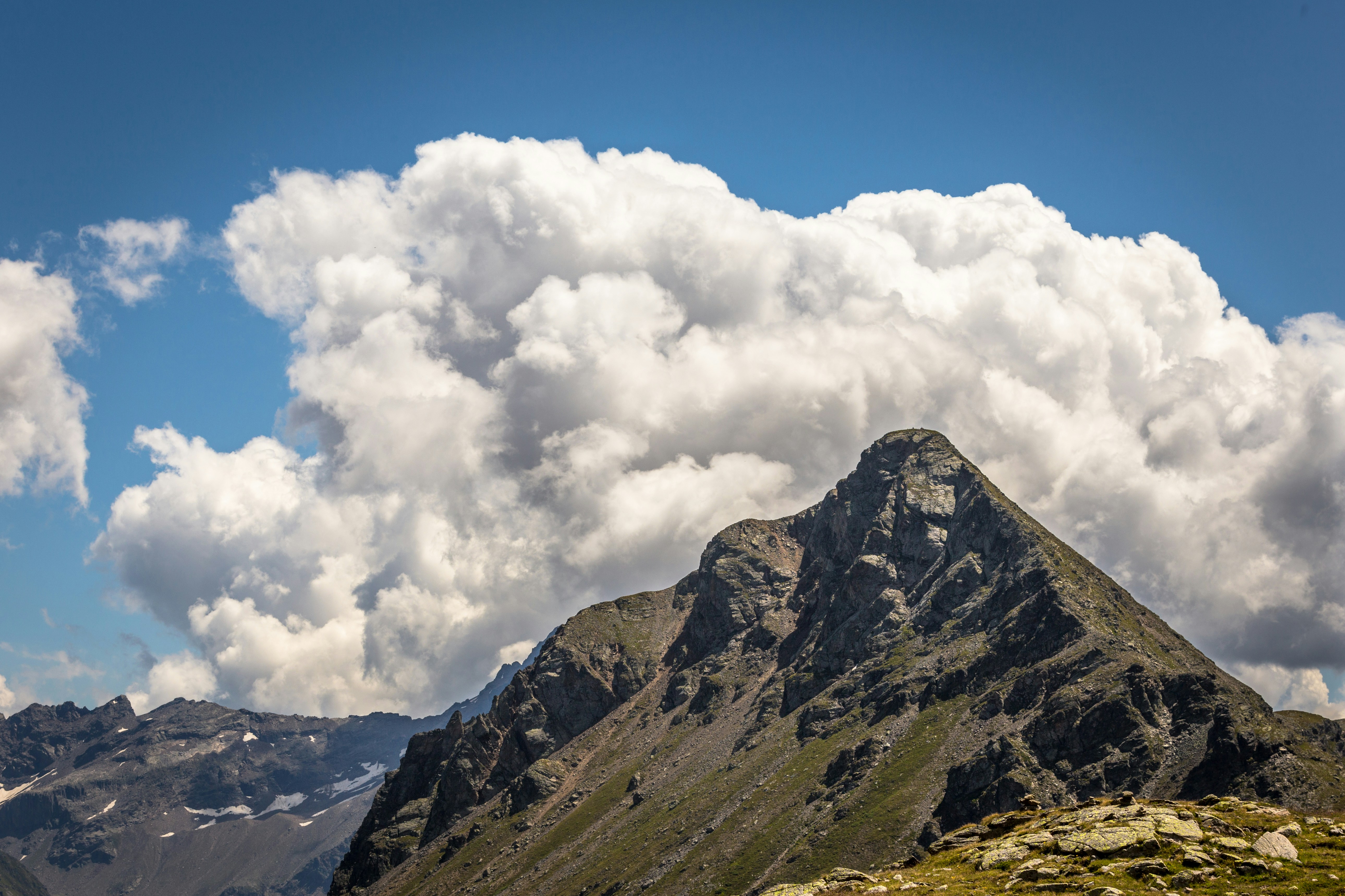 Granite Apex Under a Cloud-Carved Sky