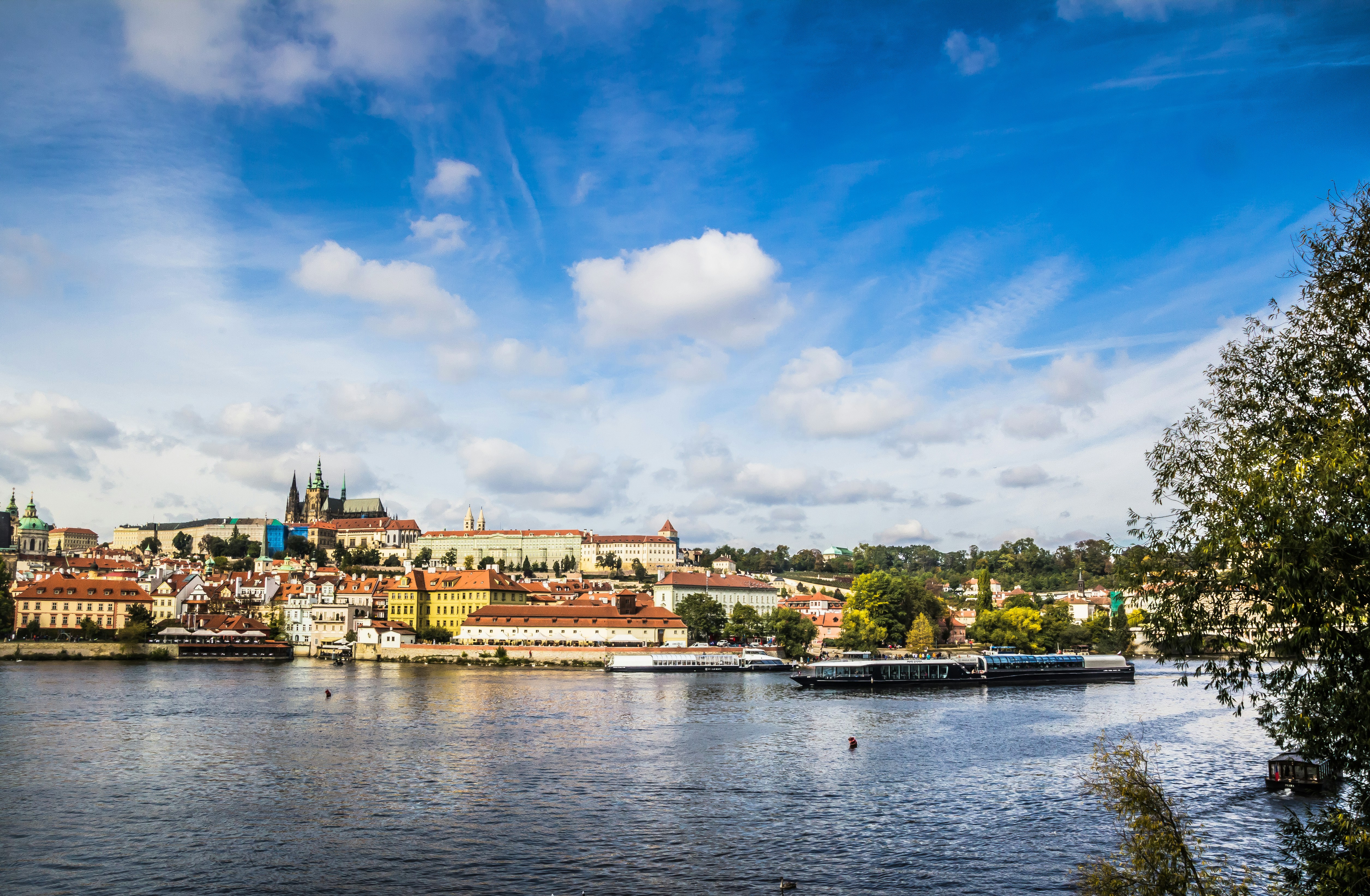Pastel Riverside: A Sunlit Waterfront of Colorful Facades and Quiet Boats