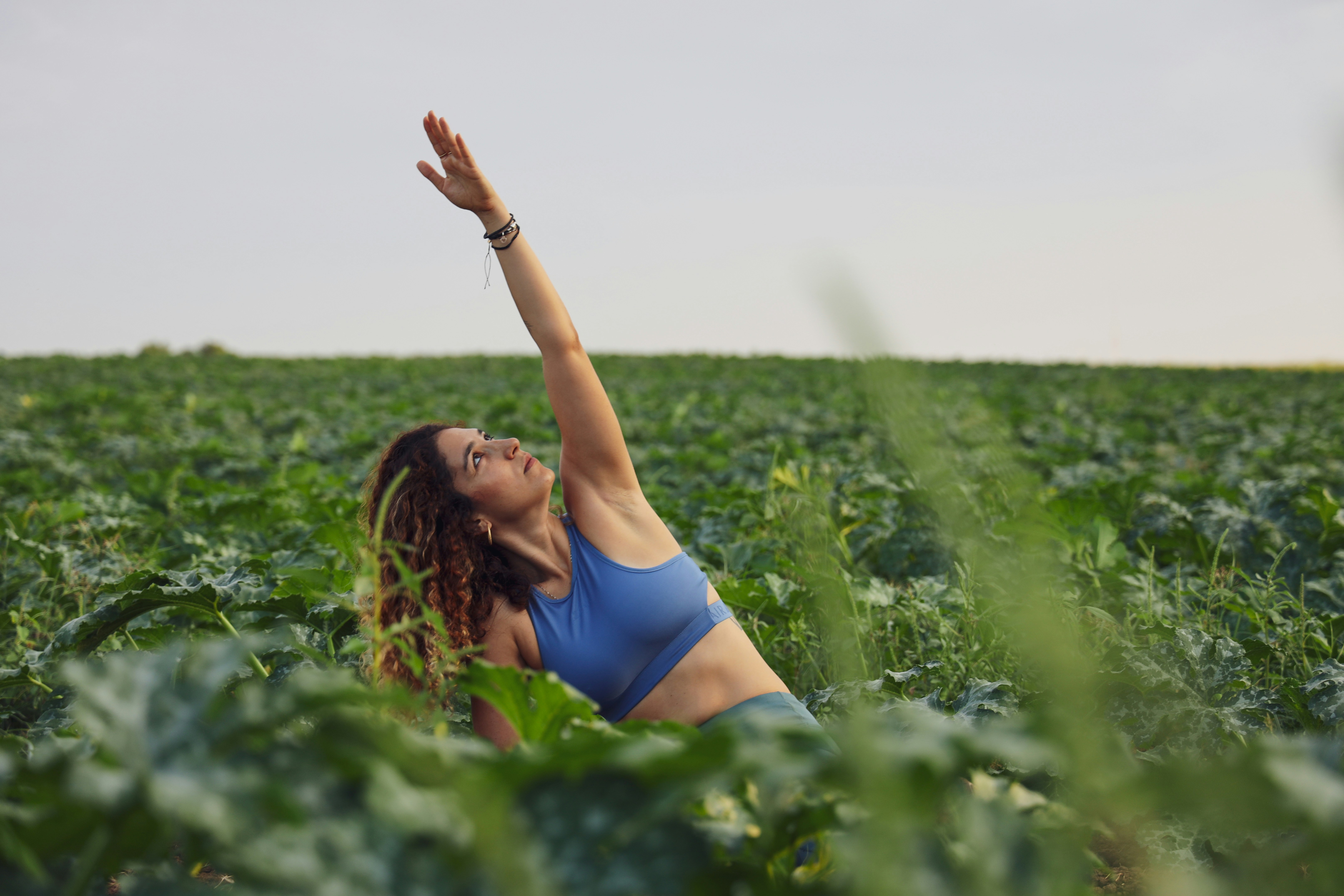 Leap of Light: A yoga pose rises above green fields