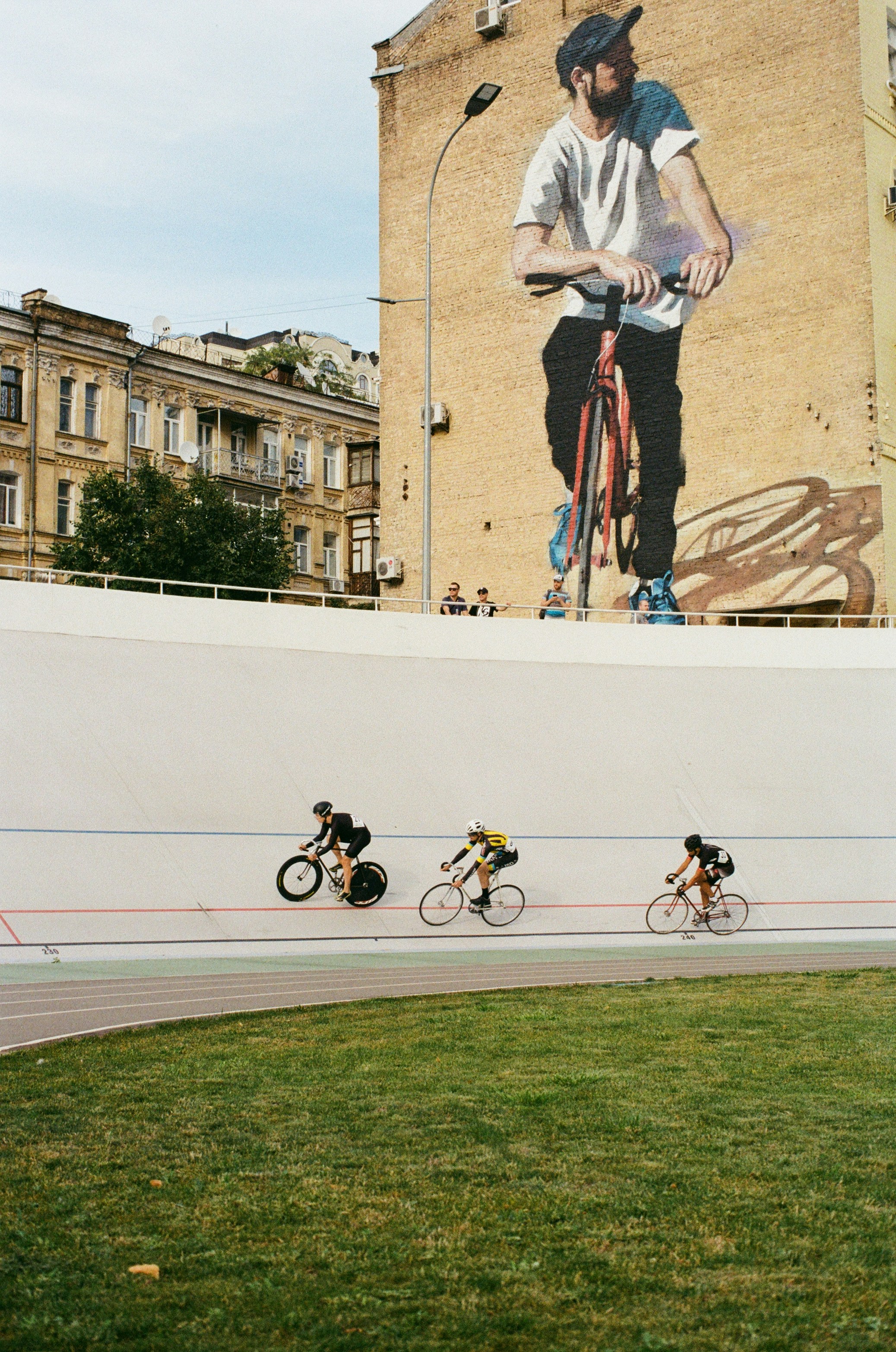 Three person riding bike on track mural photo – Free Kyiv Image on Unsplash