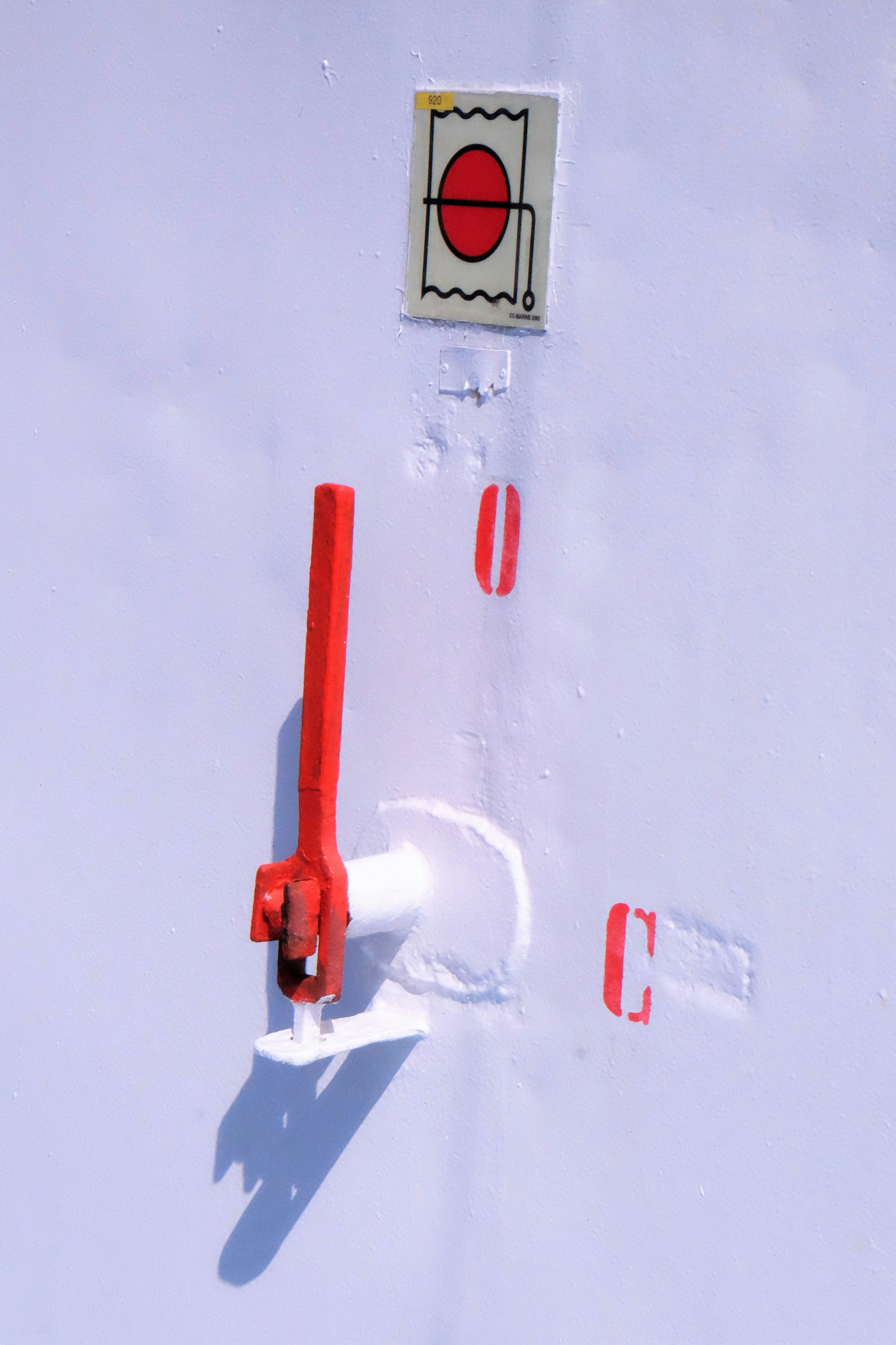 red and white metal tool