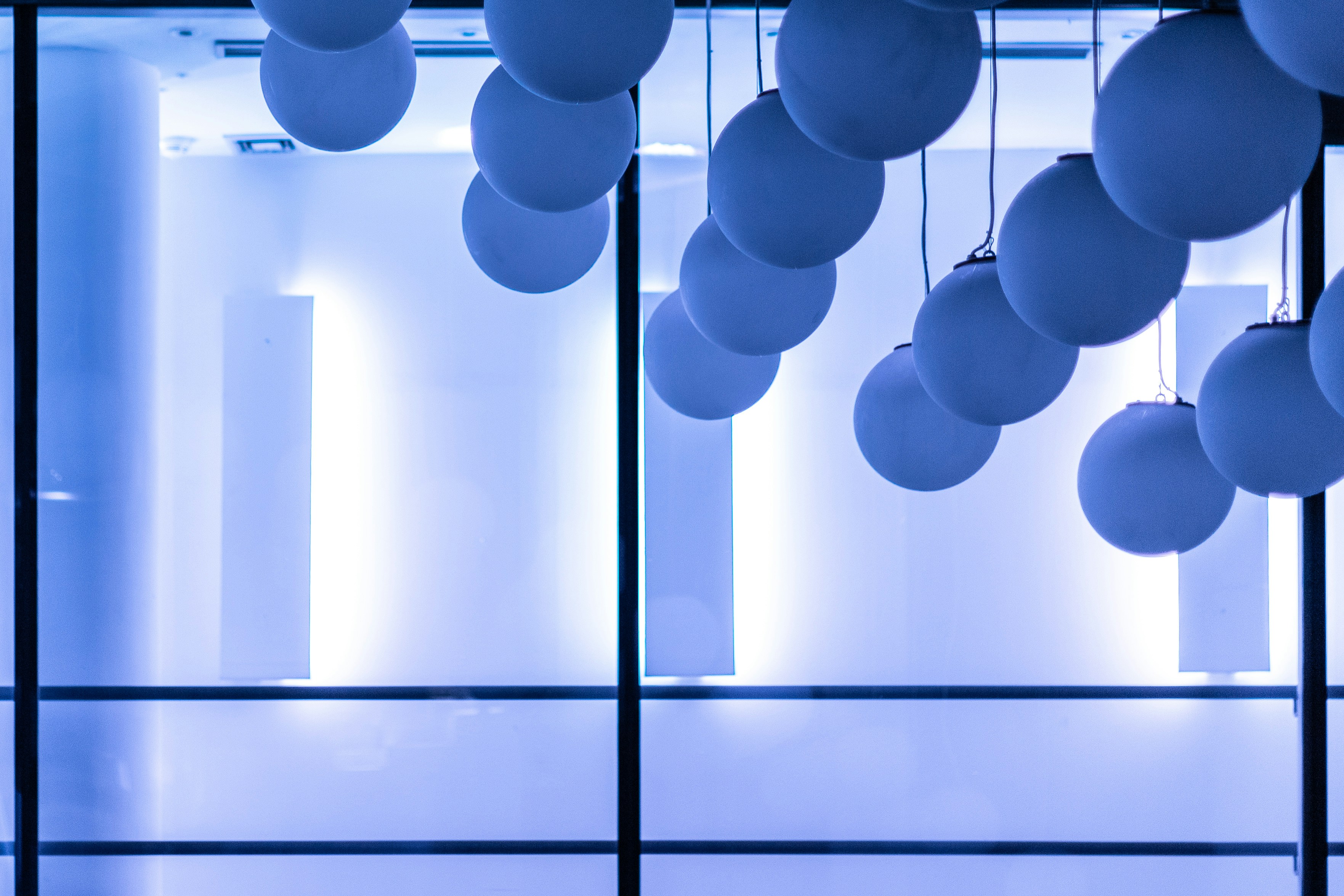 Blue Orbs in a Framed Glass Corridor