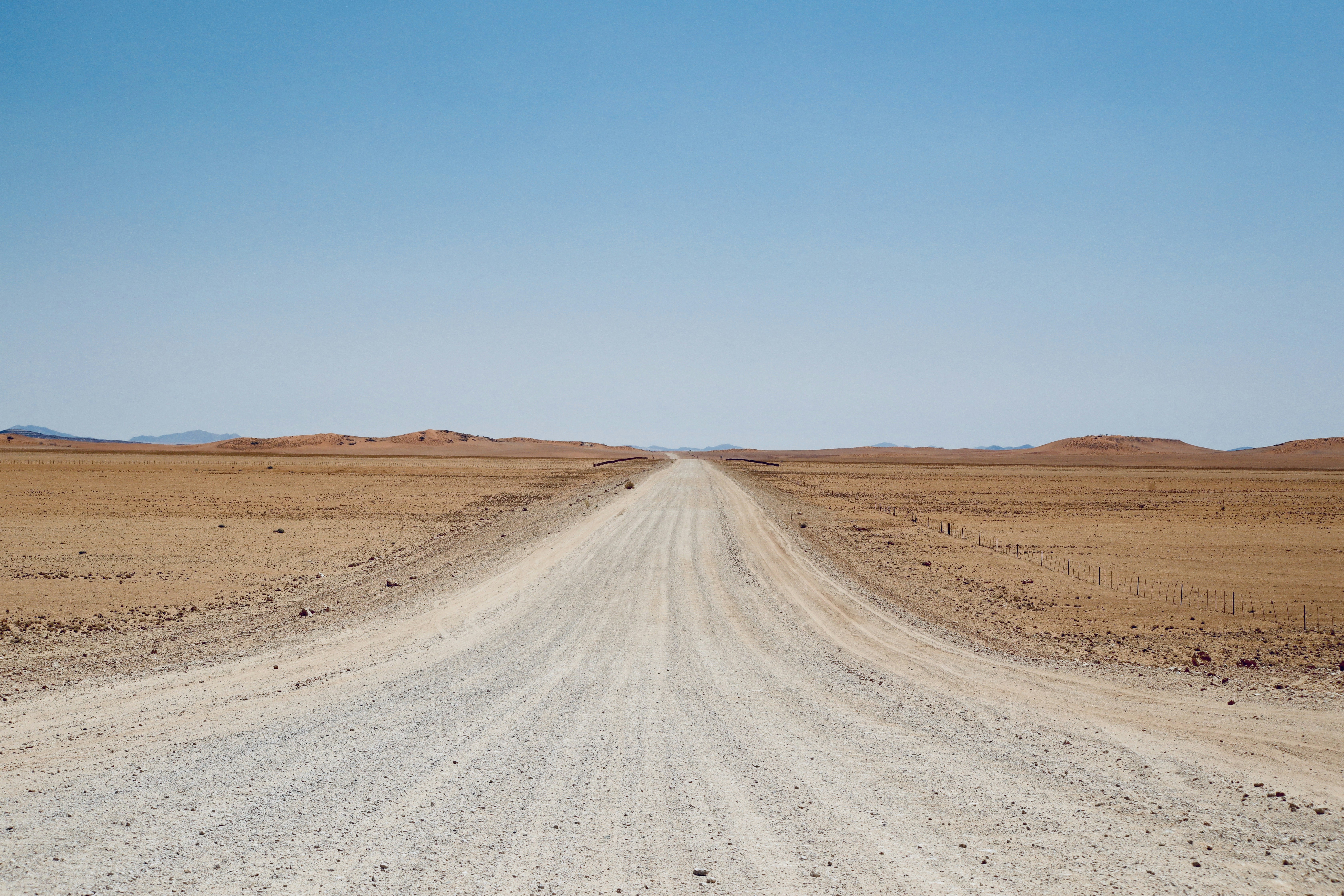 Empty dirt road under blue sky photo – Free Land Image on Unsplash