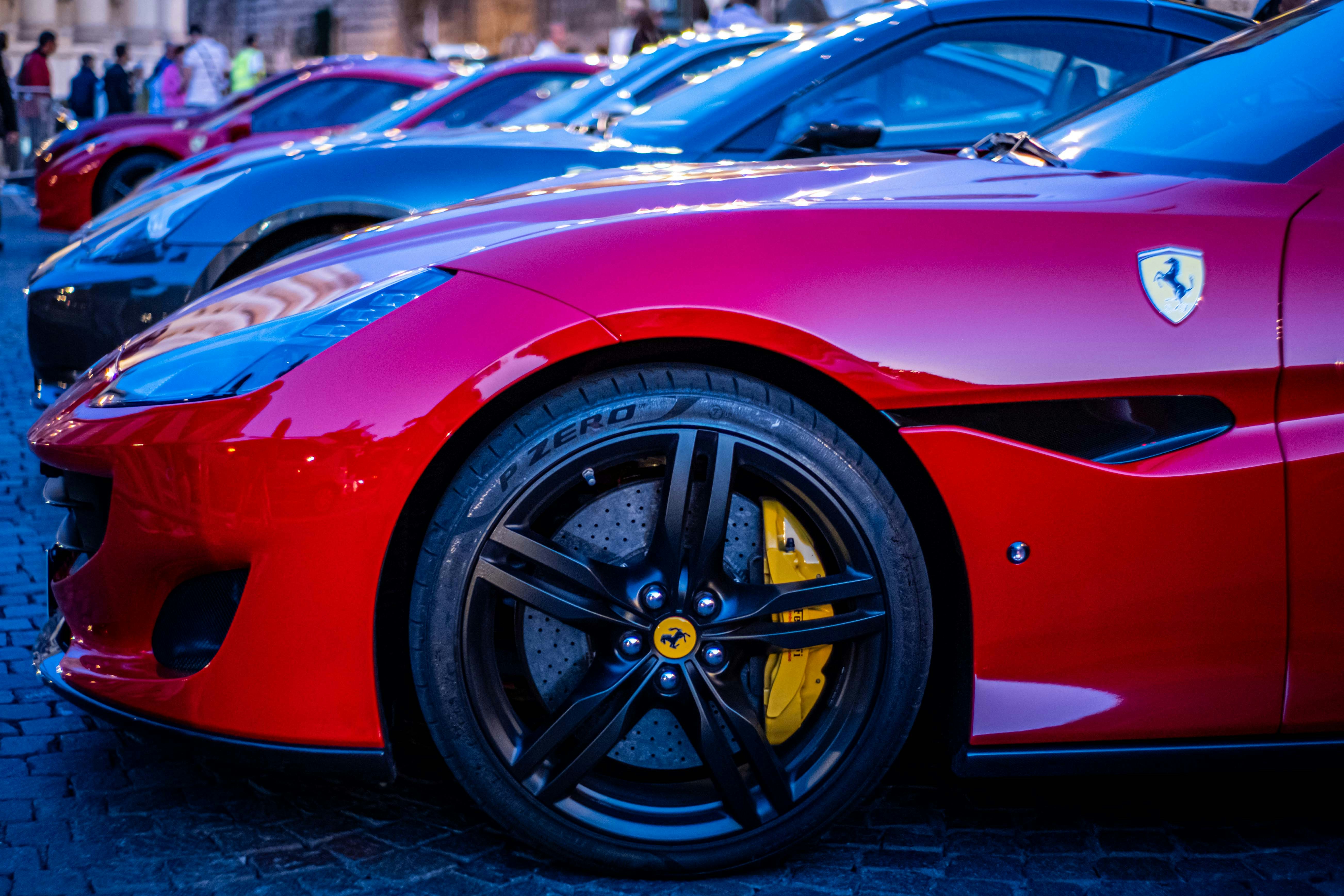 Four assorted-color sports cars on roadway photo – Free Wheel Image on ...