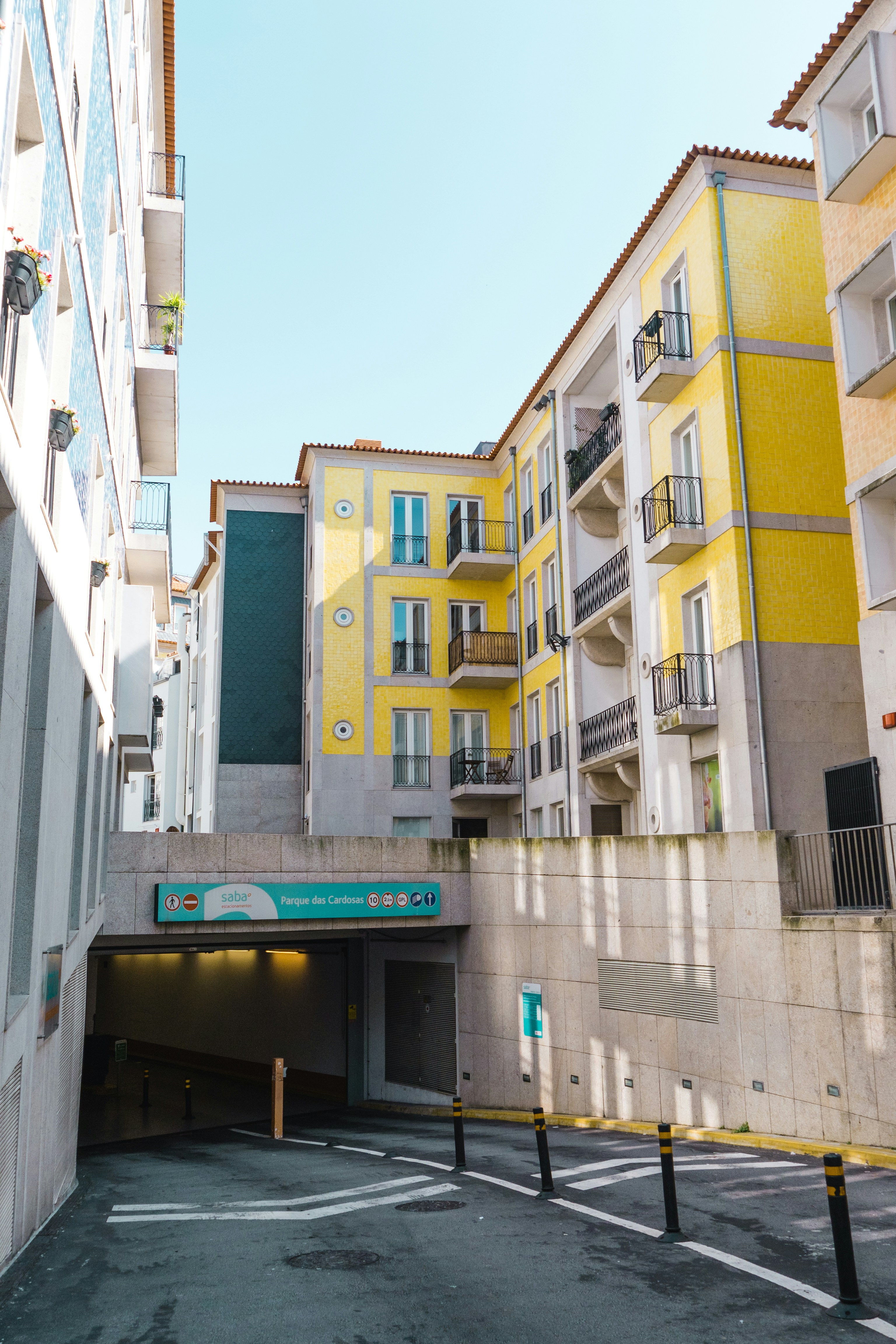 a parking garage in front of a row of apartment buildings