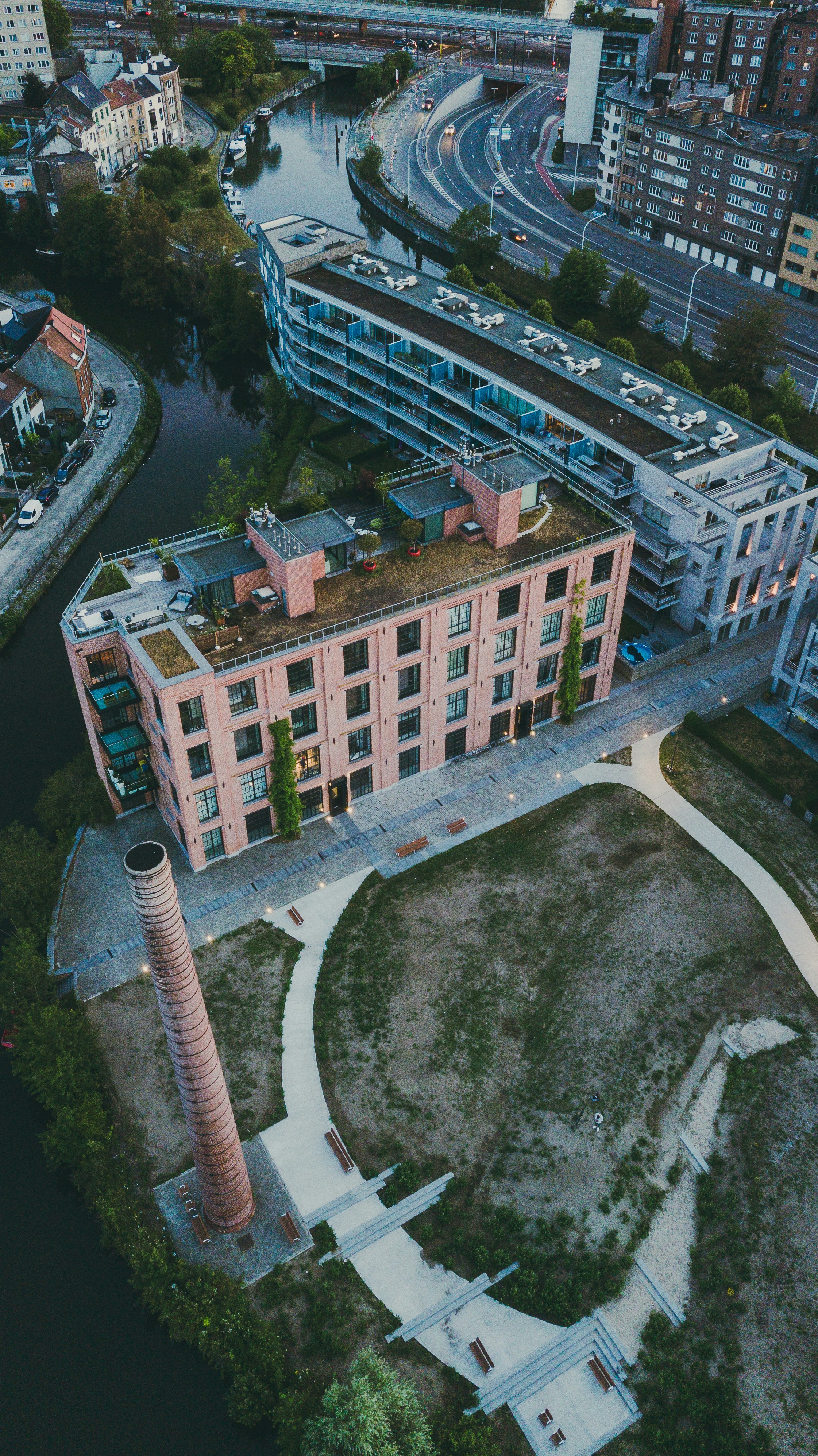 Brick-Clad Campus Over the Canal: An Aerial Slice of Urban Rhythm