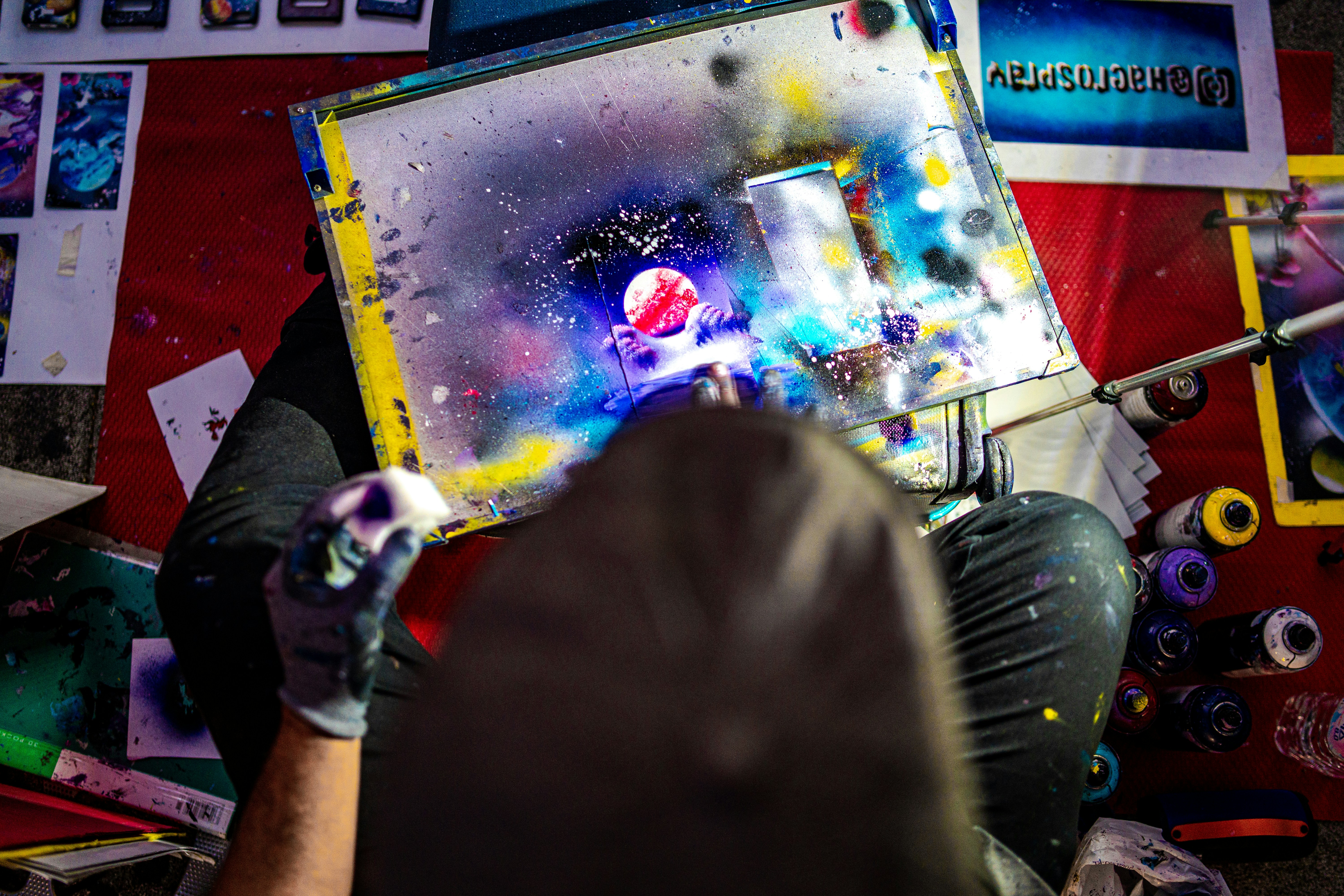 Neon Cosmos from Above: A Painter’s Spray-Paint Studio Scene