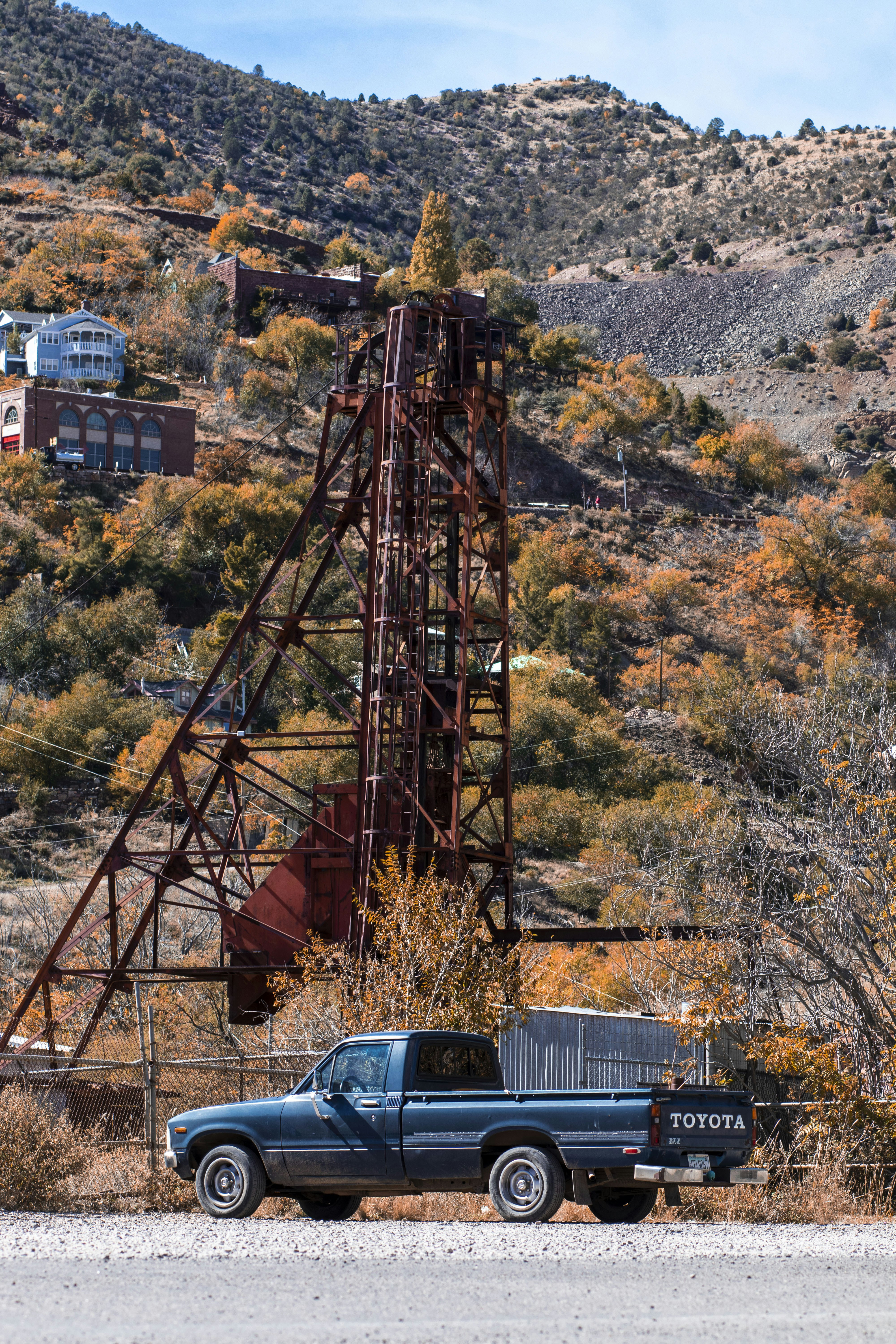 Black single-cab pickup truck beside red metal frame during daytime ...