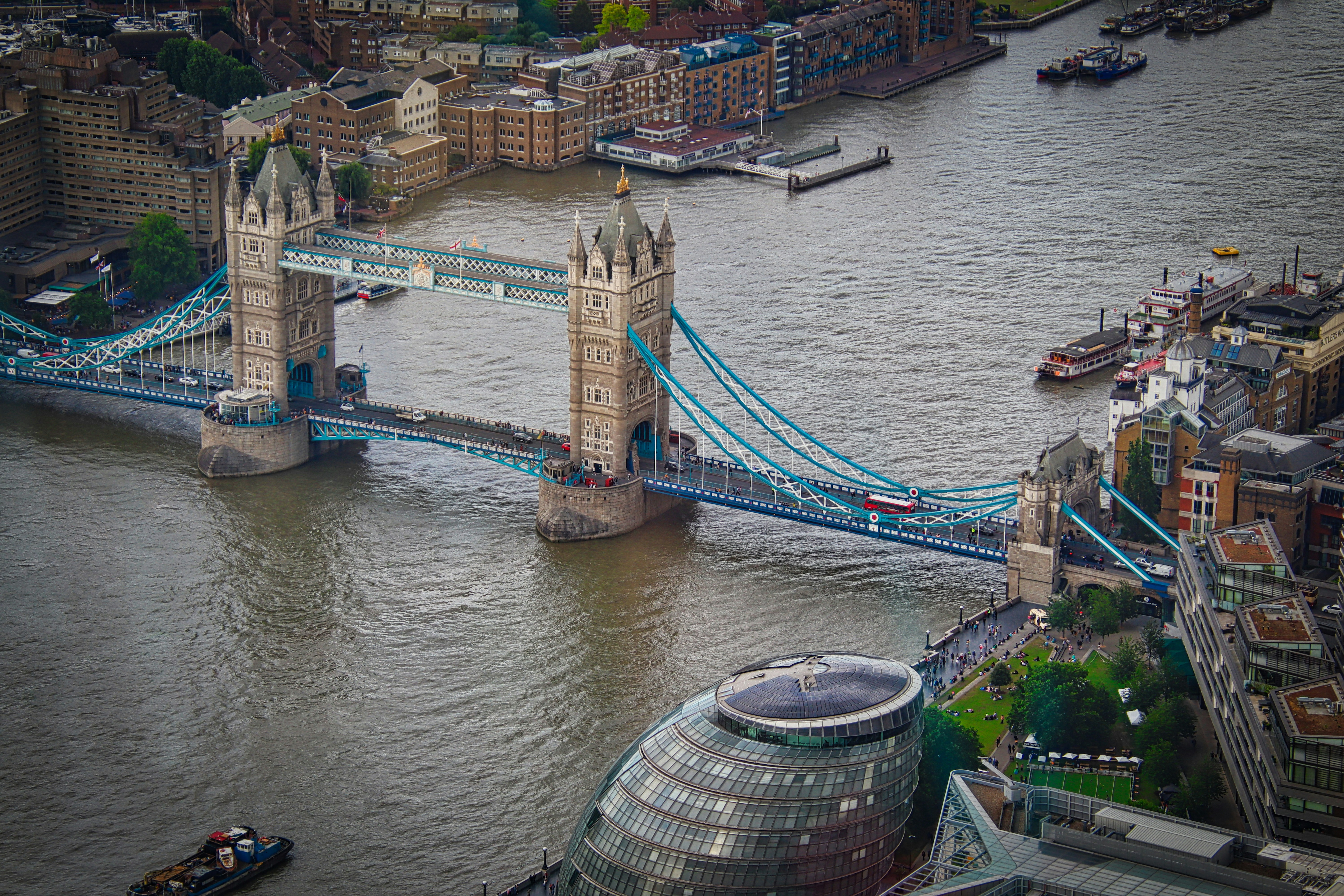Tower Bridge Framed by the Thames and City Hall Dome — An Aerial Cityscape