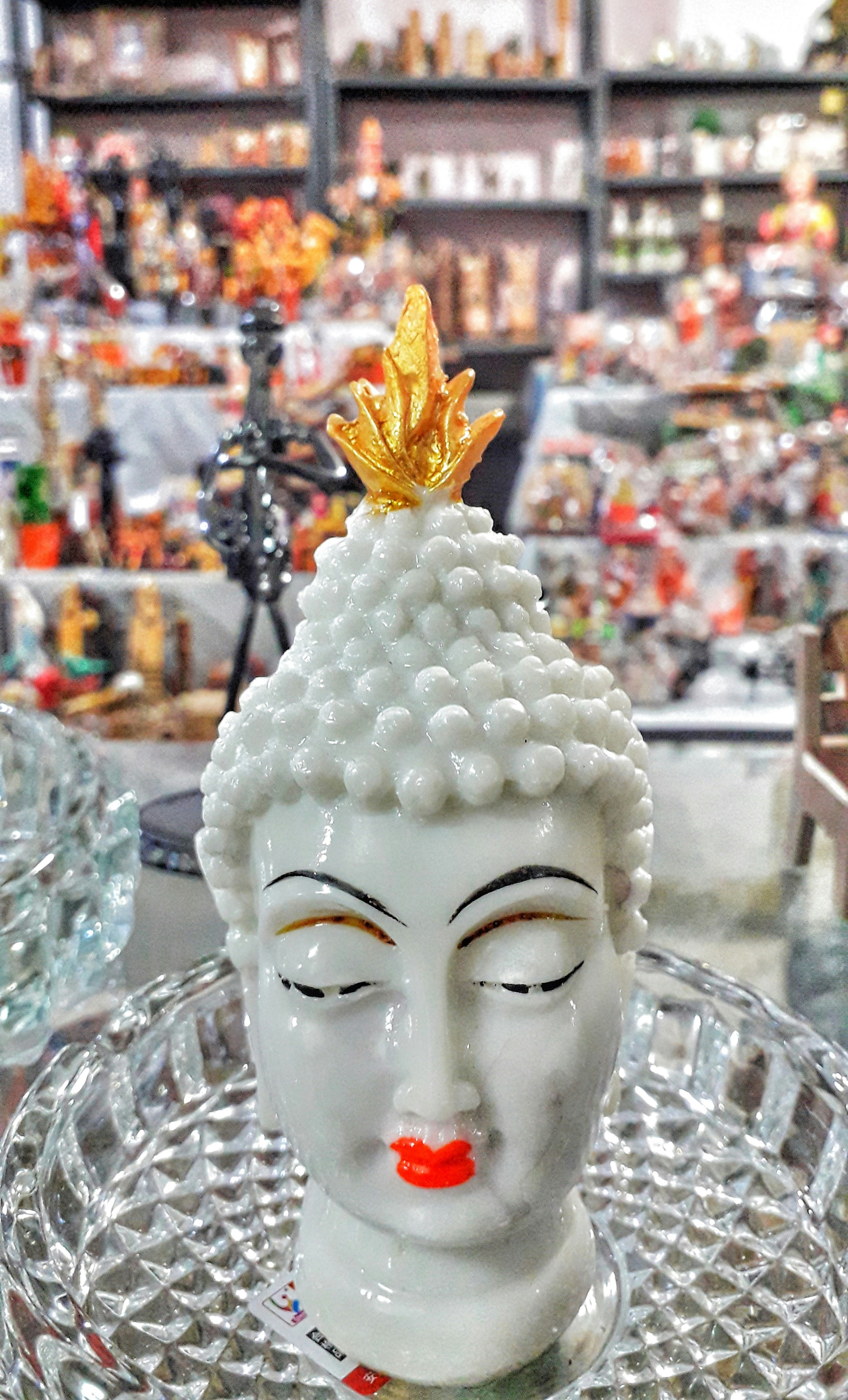 Radiant Buddha Bun: A Ceramic Wonder Amid Glass Artifacts