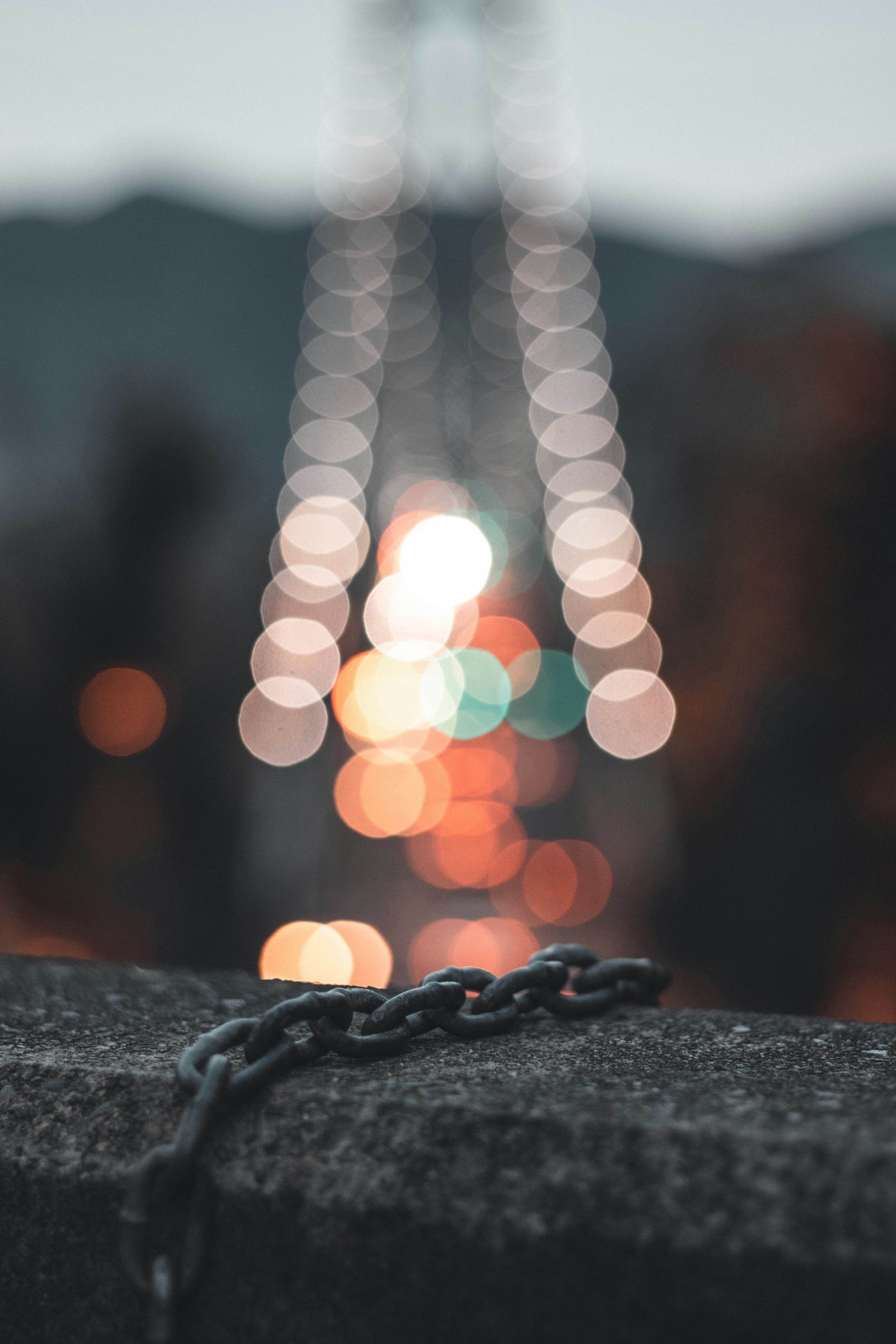 Rusted Chain at Dusk: Neon Lights in Soft Focus