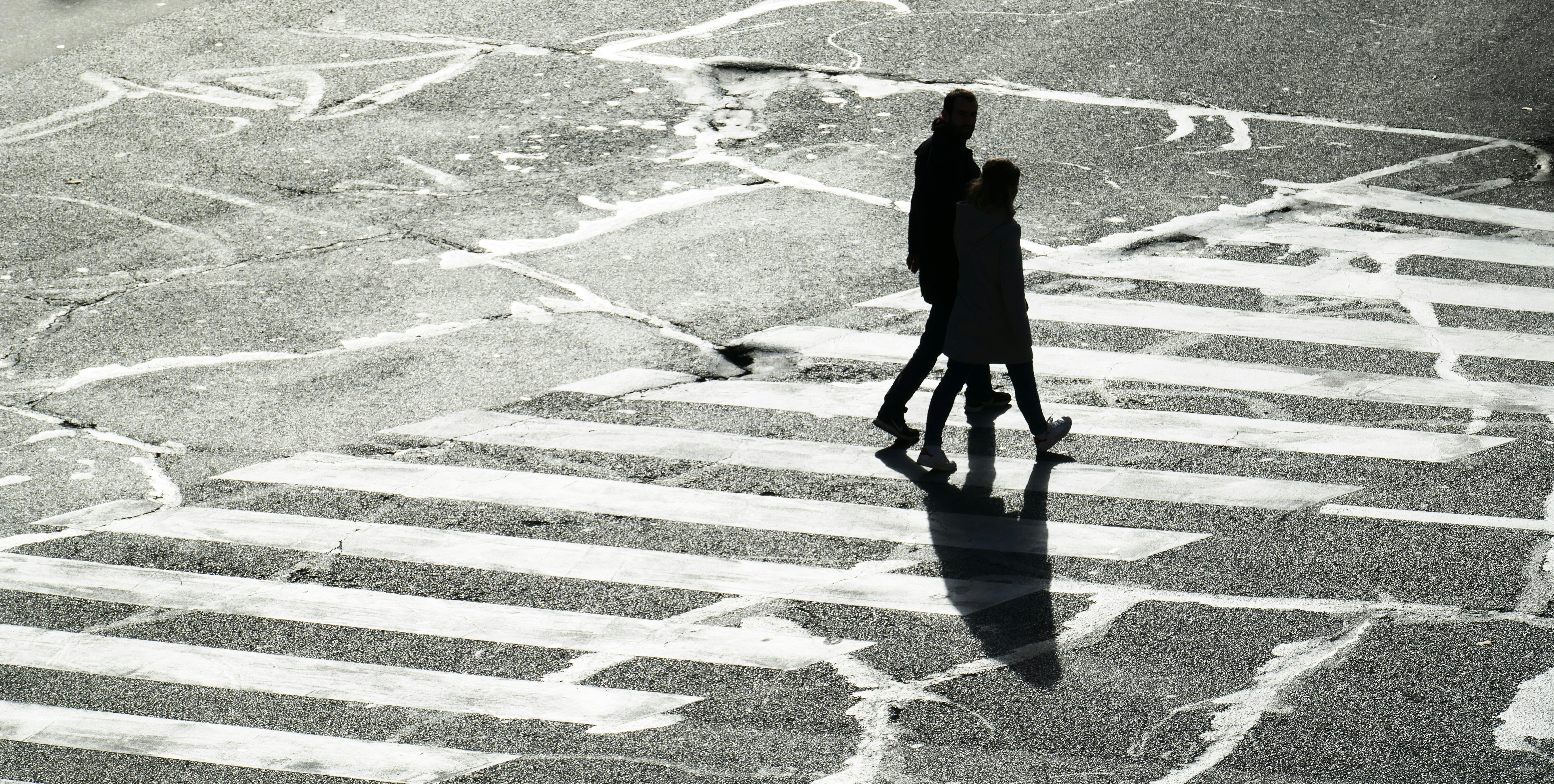 Two persons crossing pedestrian lane photo – Free Human Image on Unsplash