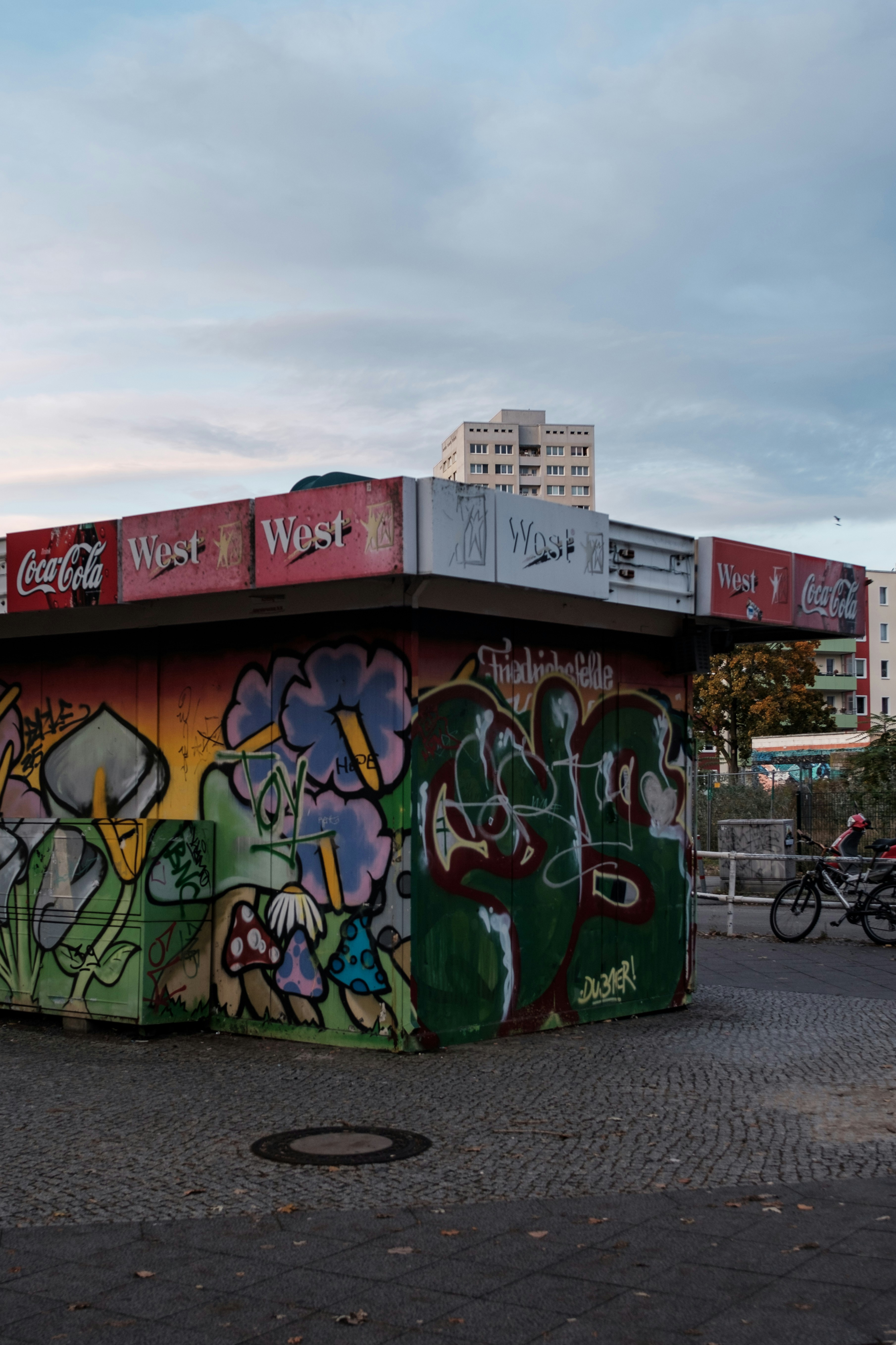 Graffiti Corner: The Painted Kiosk Beneath a Quiet Urban Sky