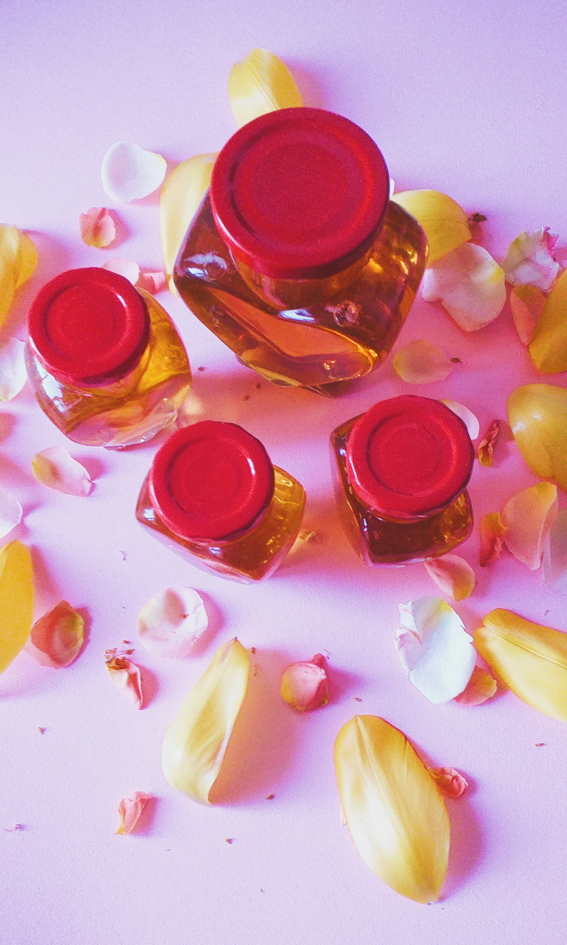 Amber Bottles on a Petal-Pink Stage: A Delicate Still Life