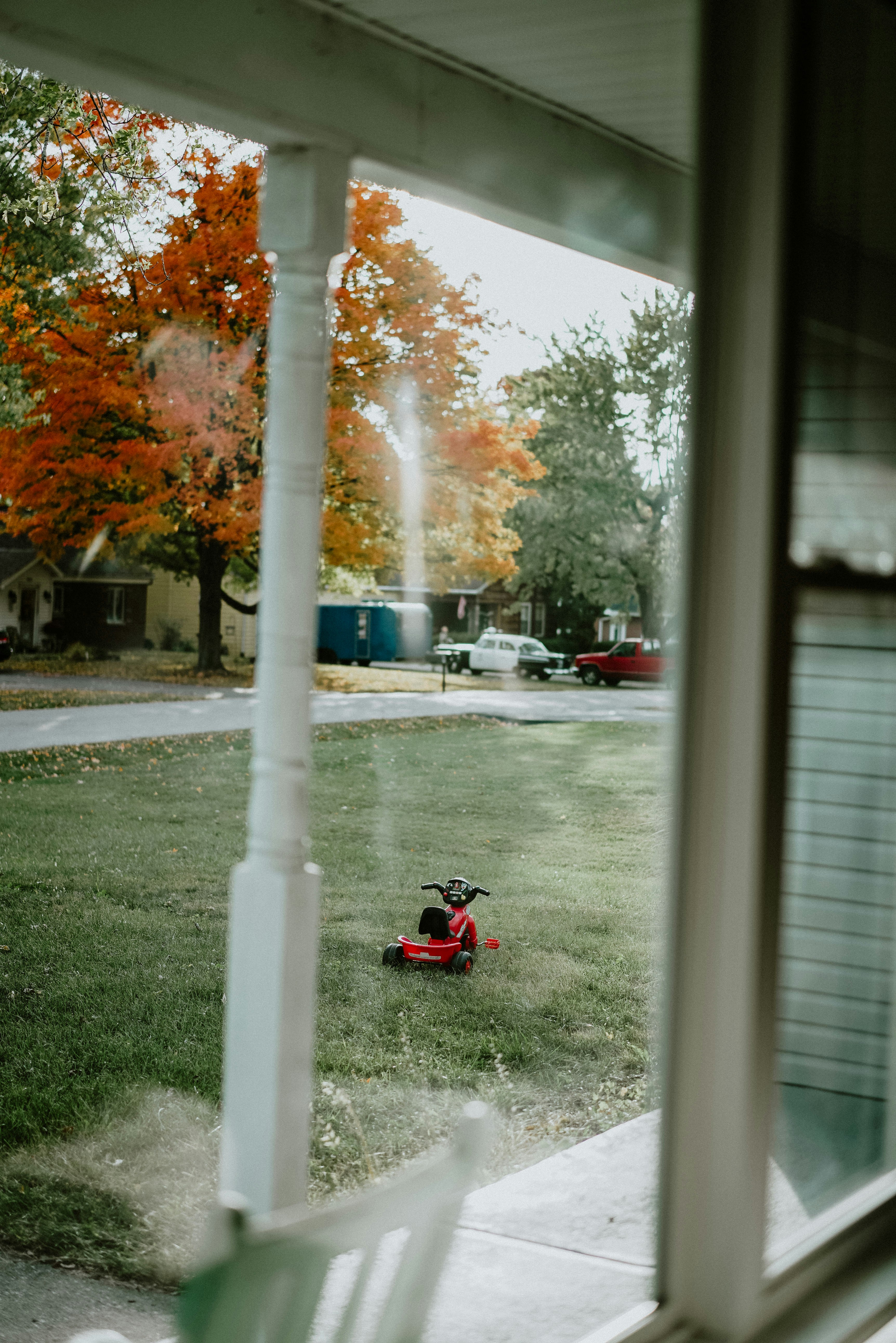 An American Suburb with a toy in the front yard and maple in the back 