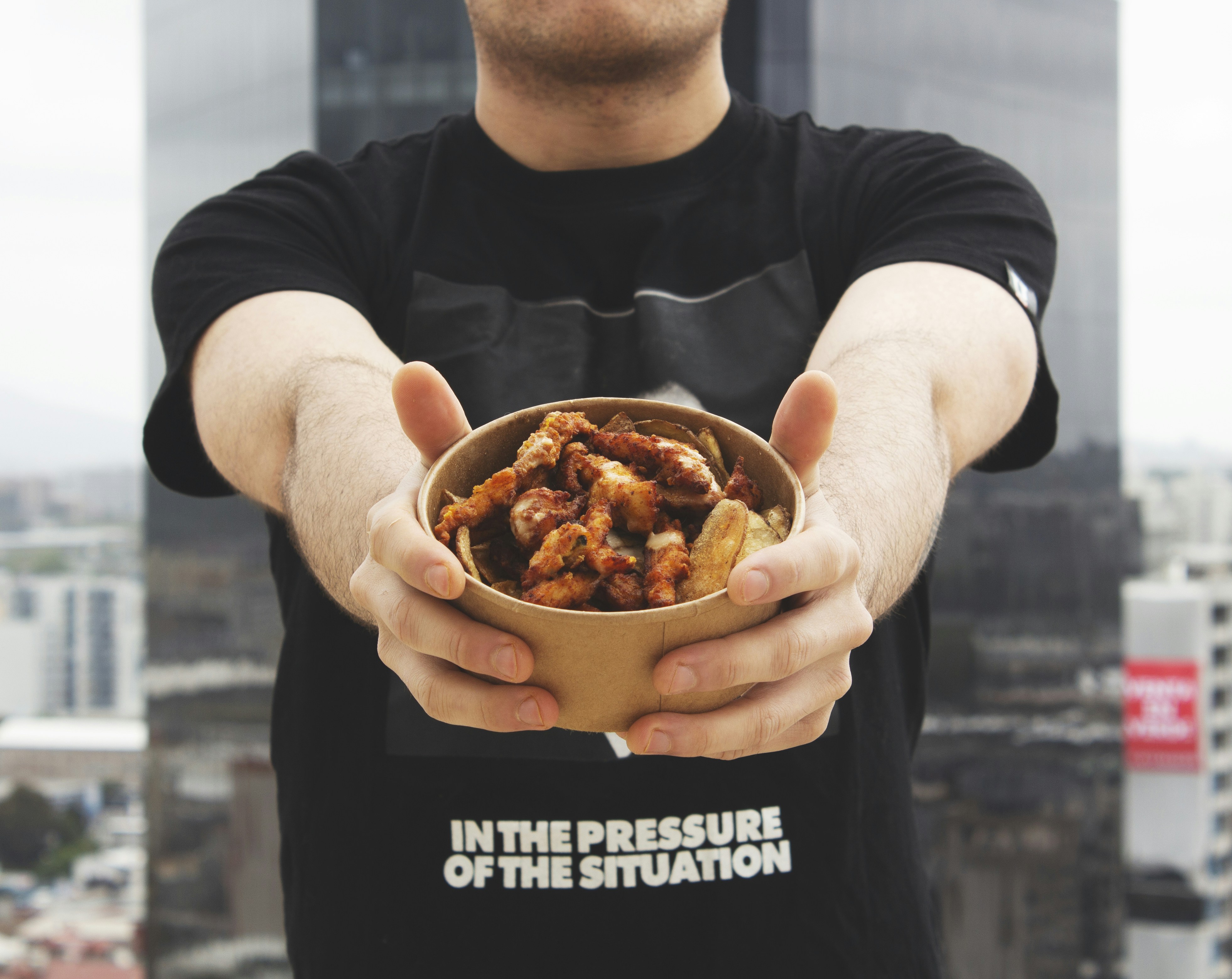 Crunch at the Edge: Fried Chicken Reaches Toward a Blurred Skyline