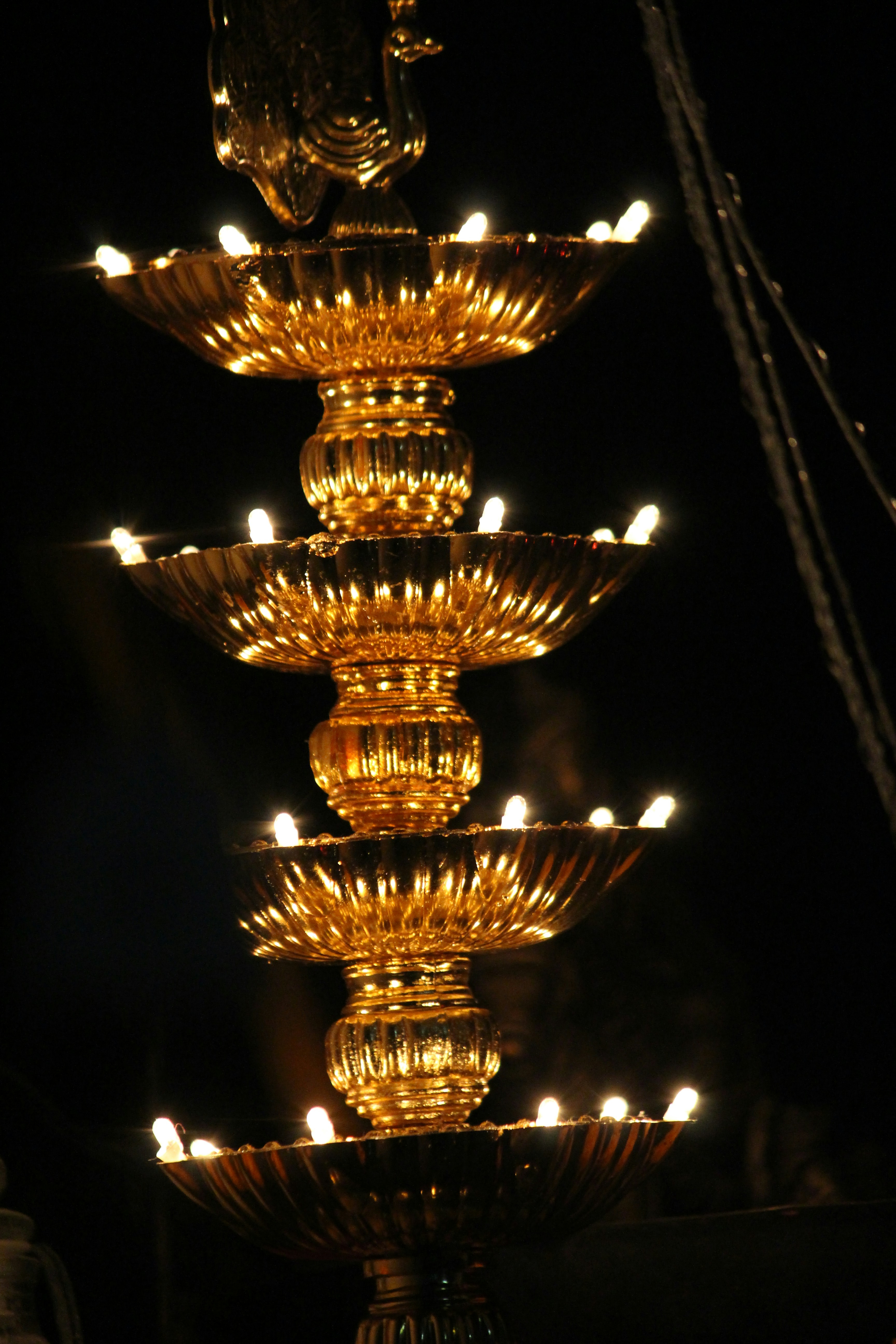 Golden Tiered Lamp Tower Illuminates Night with Quiet Fire