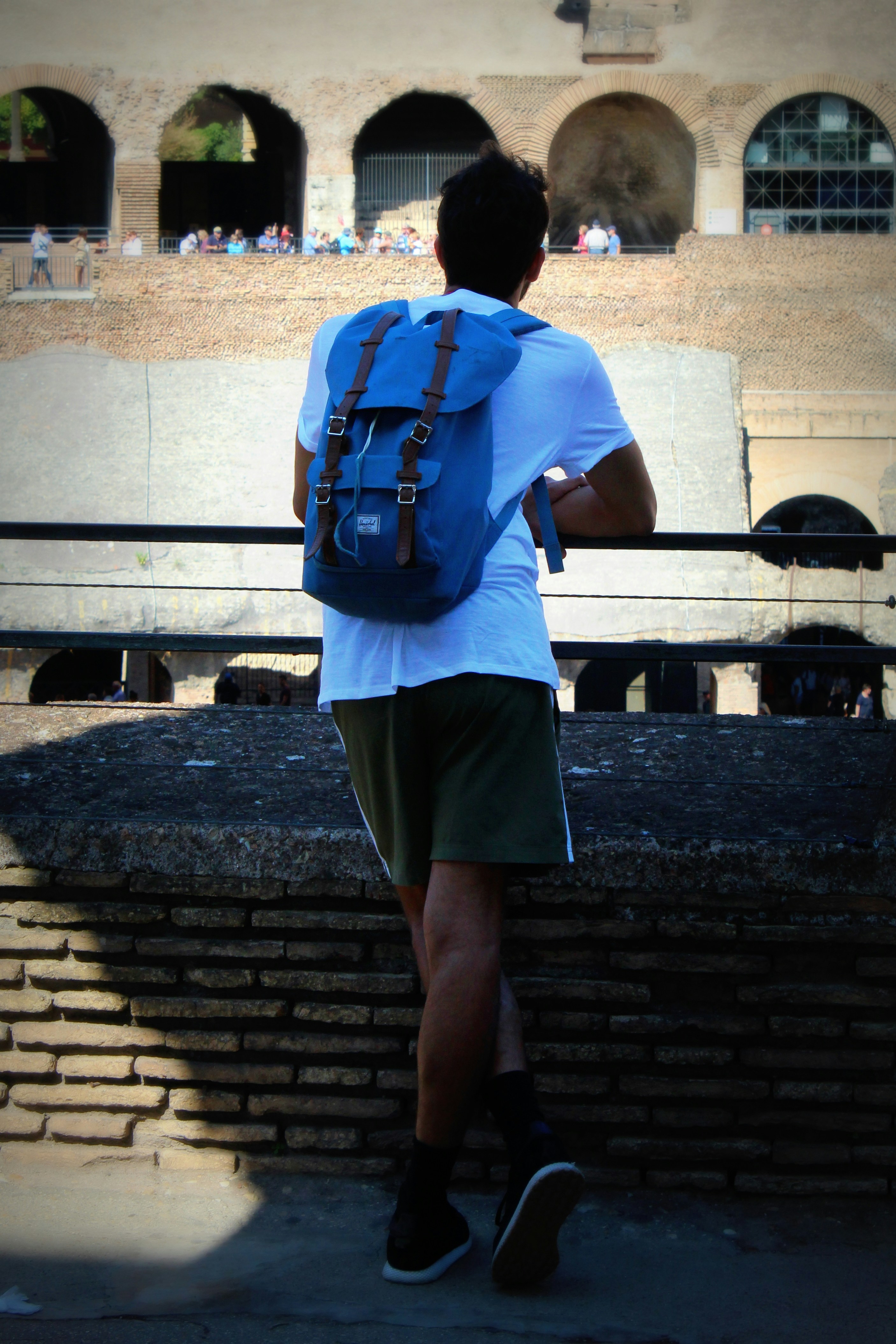 Backpack Portrait Over the Ancient Brick Arcades