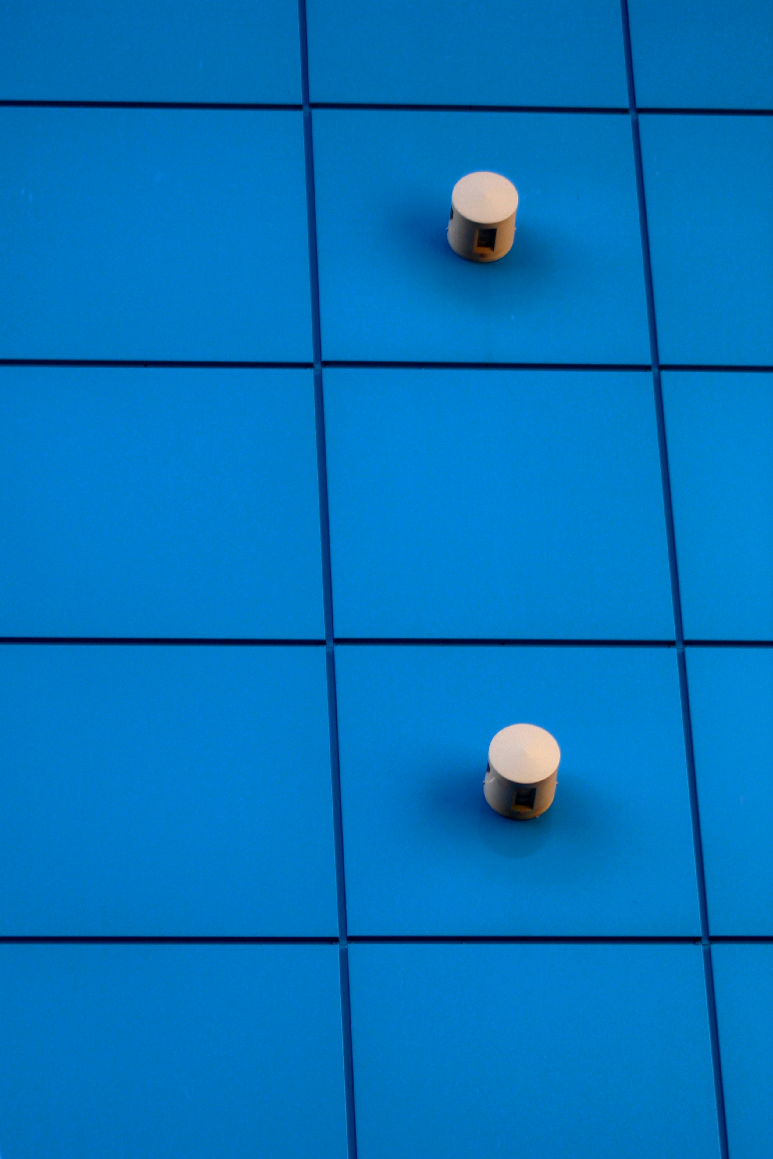 Two white caps on a vivid blue grid