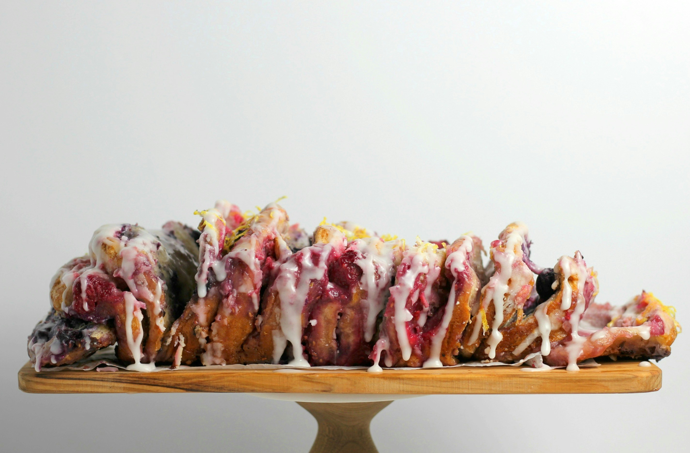 Glazed Pastry Stack on a Wooden Pedestal