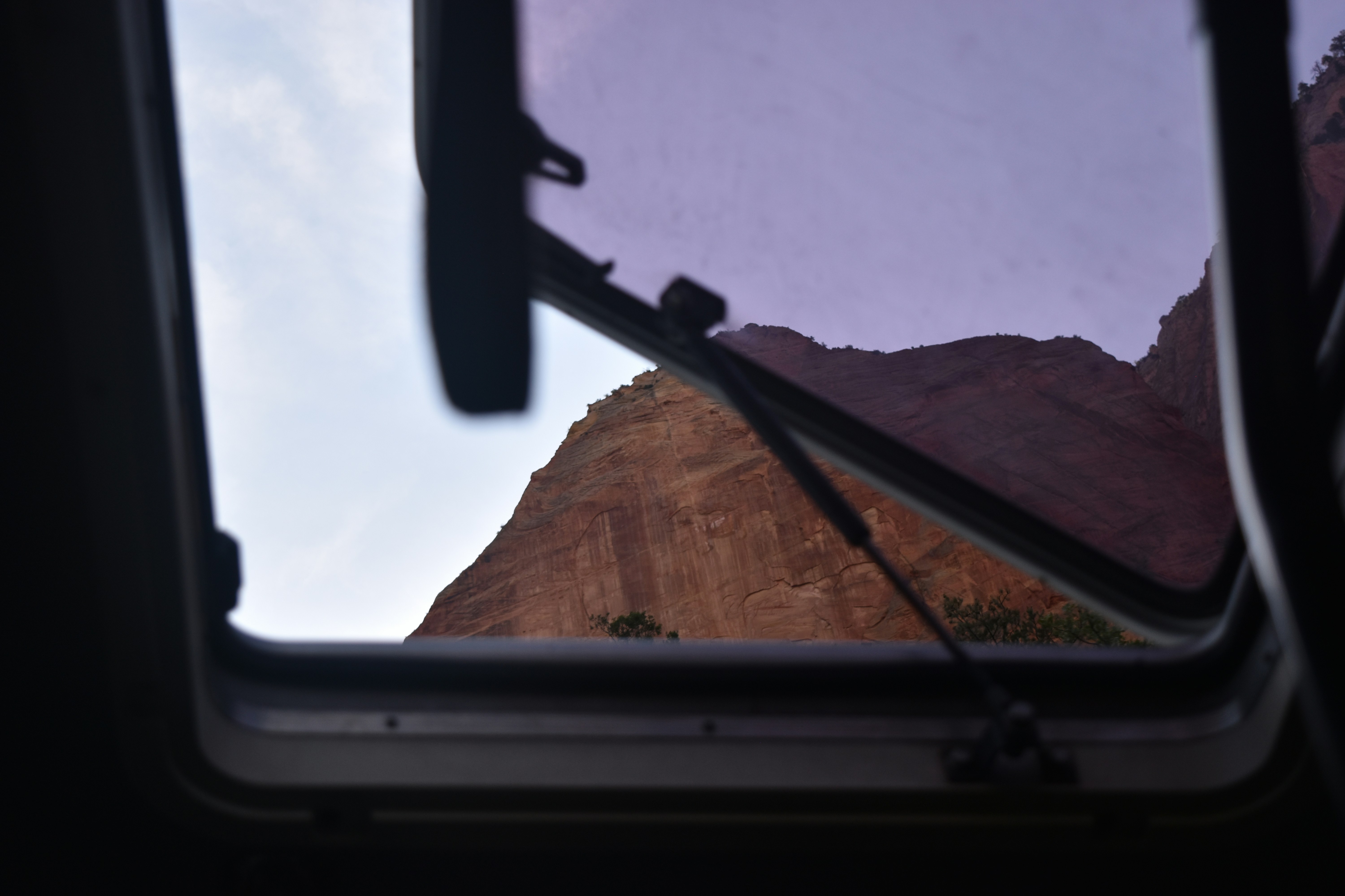 Crimson Cliffs Through a Vehicle Hatch: A Canyon Portrait