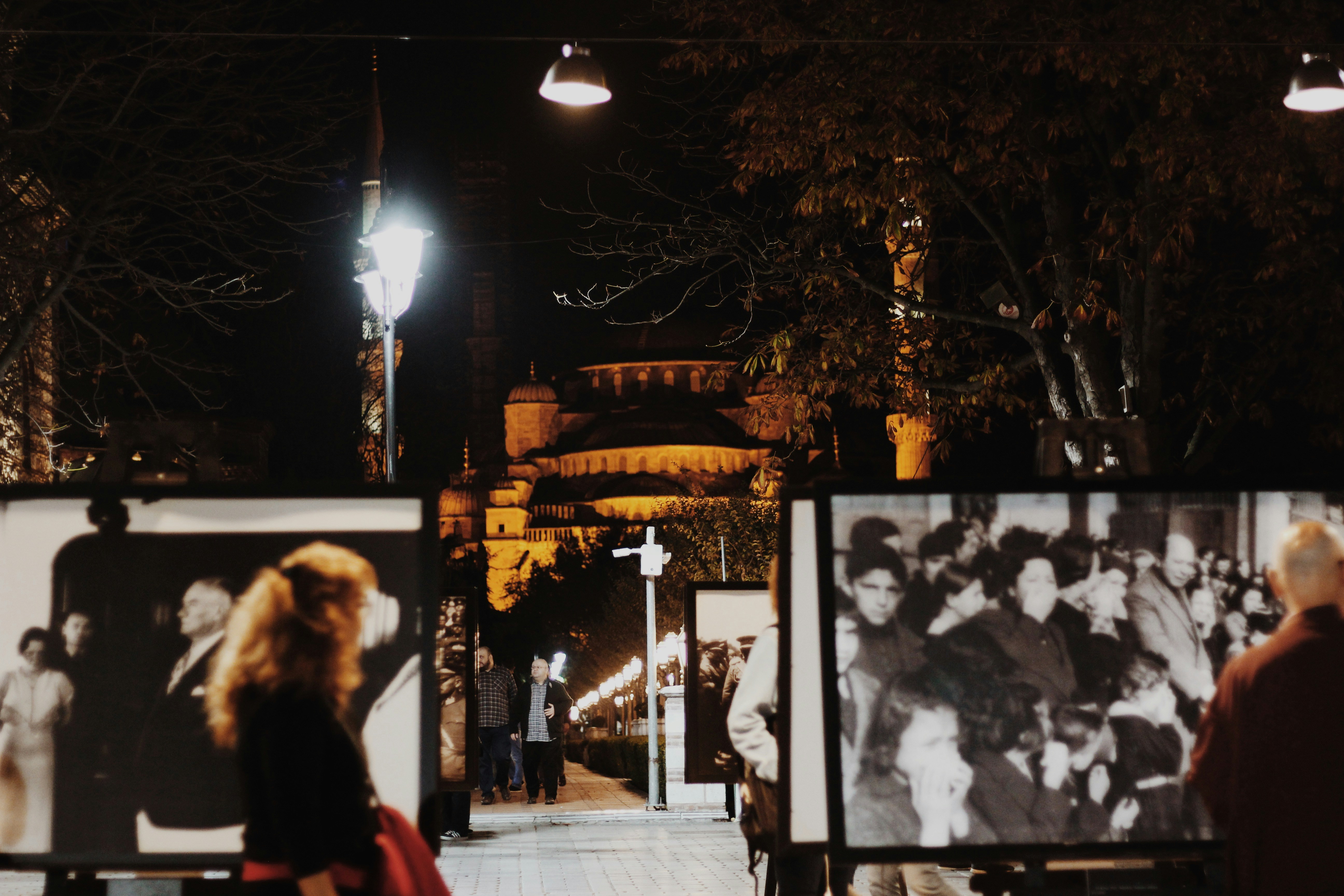 Midnight Gallery Lane: Illuminated Portrait Panels Framing a Quiet Night Walk