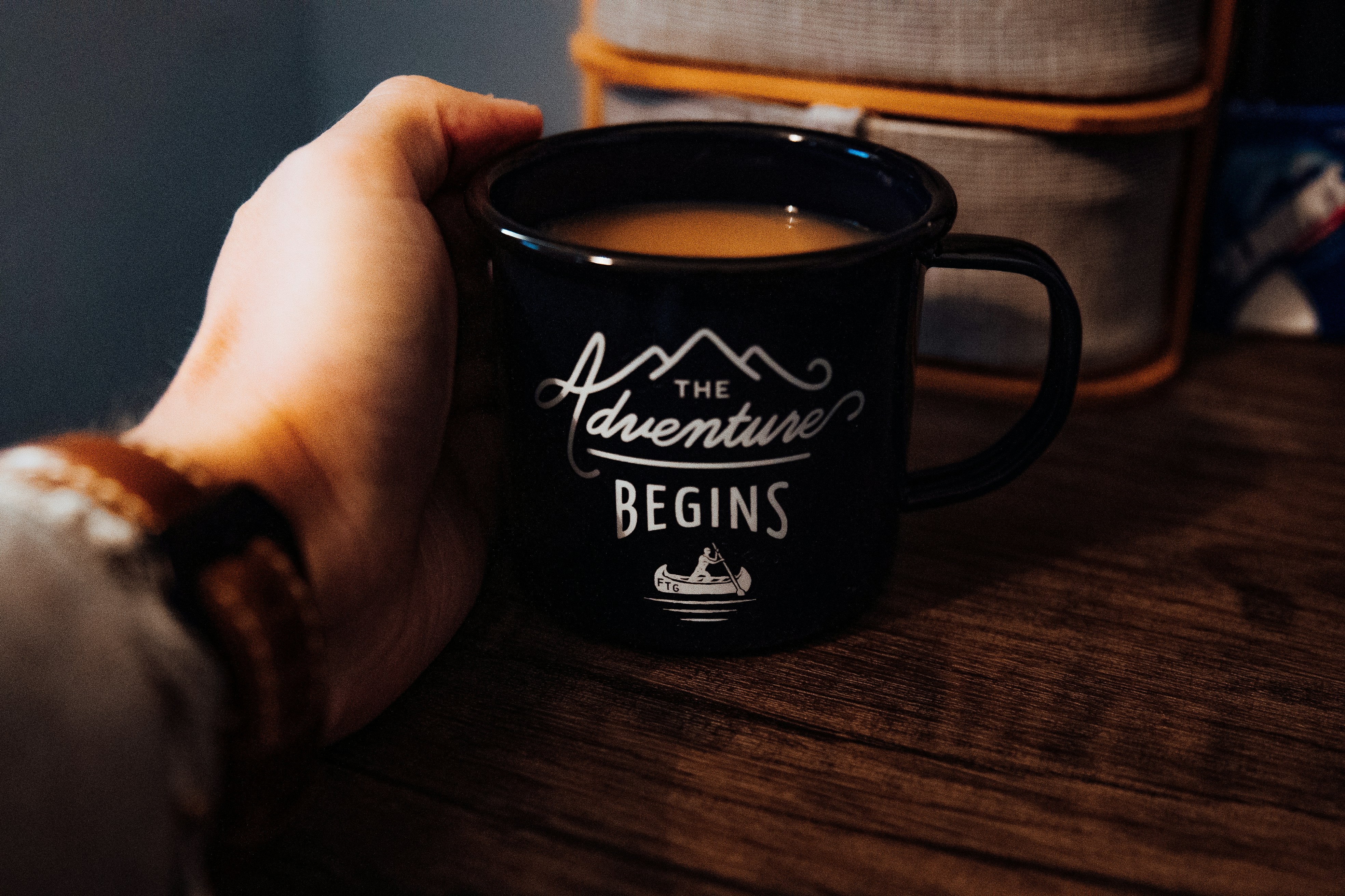 person holding black mug