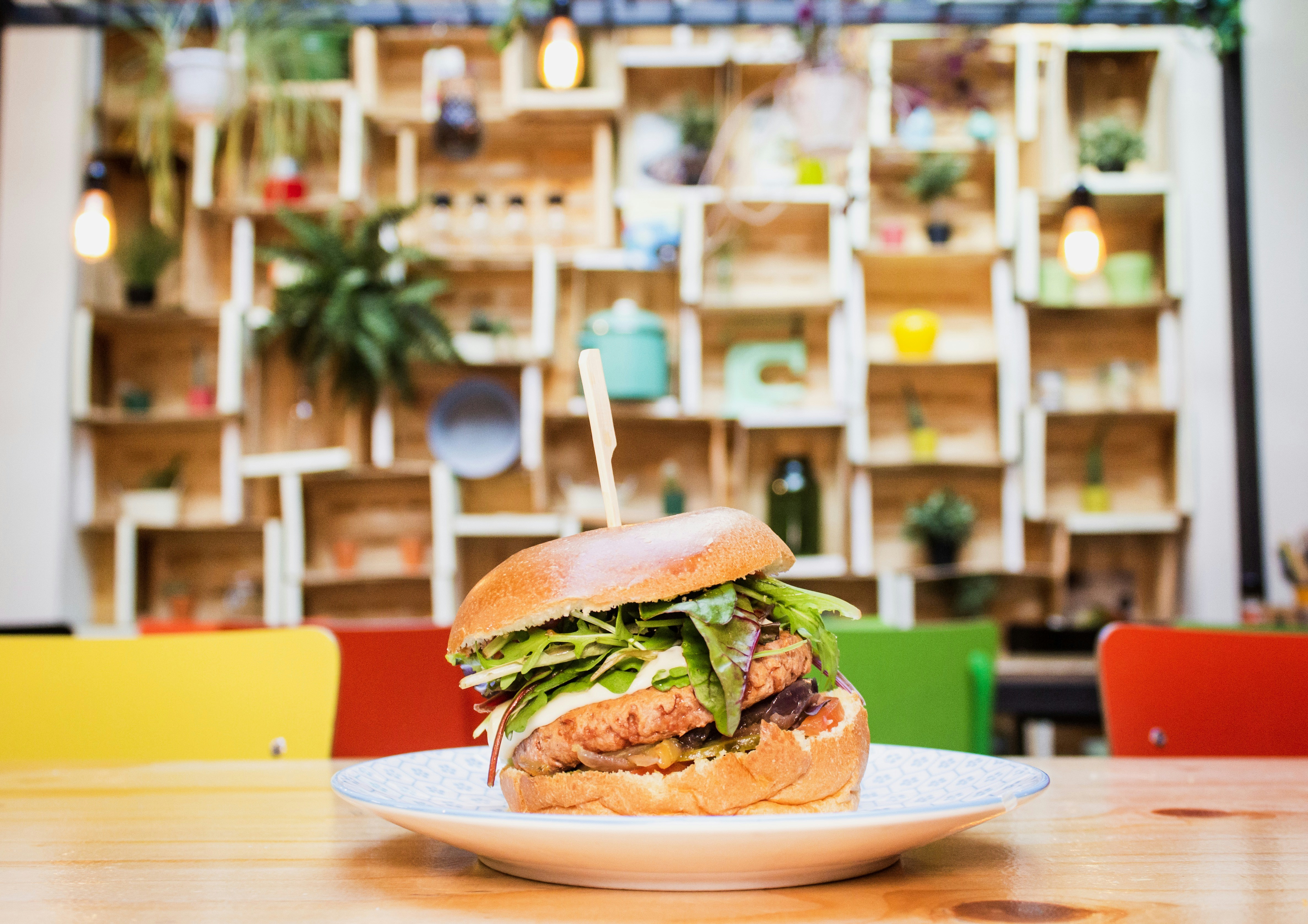 Burger in the Spotlight Amid a Patchwork Café Backdrop