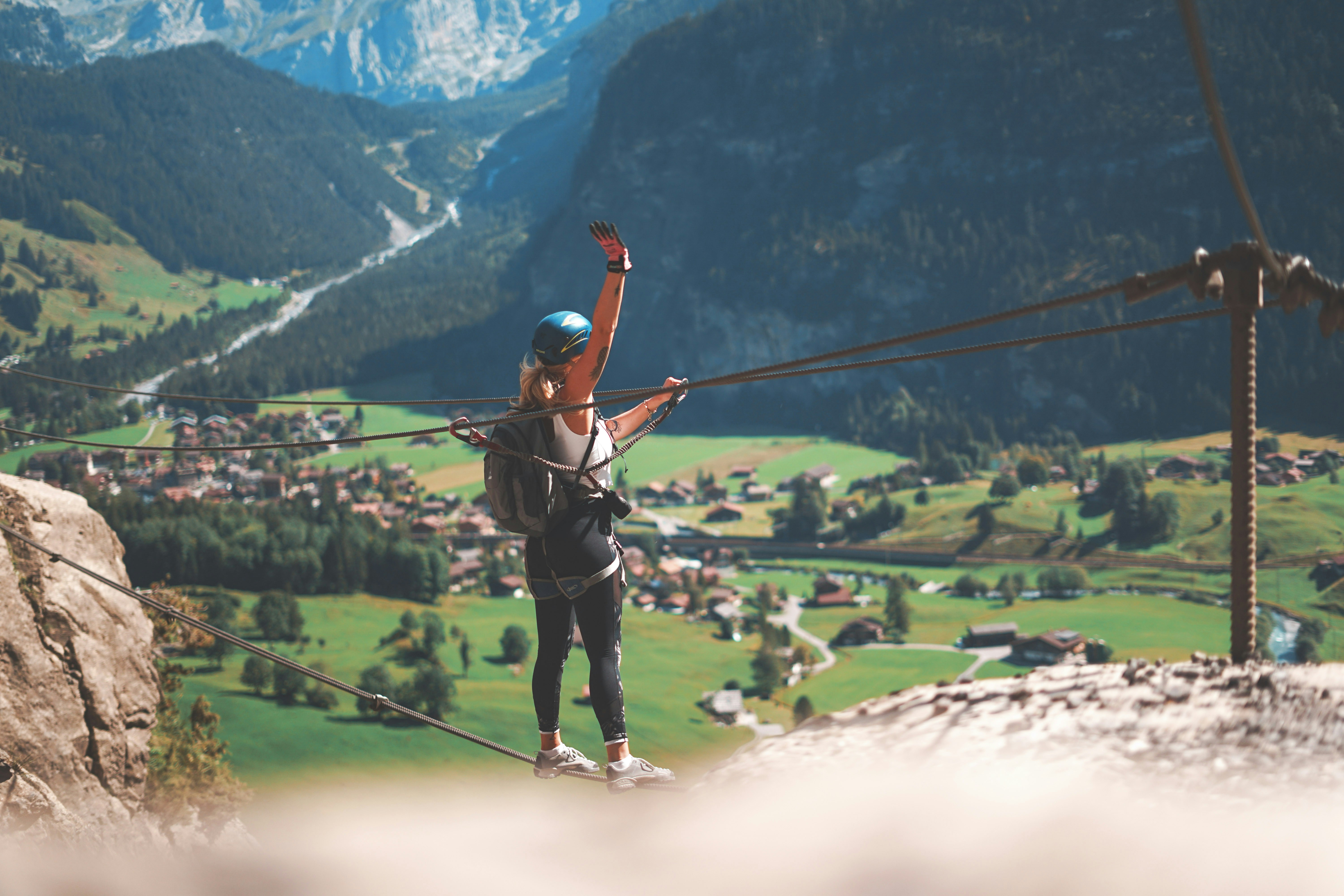 Edge of Ascent: Harnessed Traveler Traverses an Alpine Zip Line
