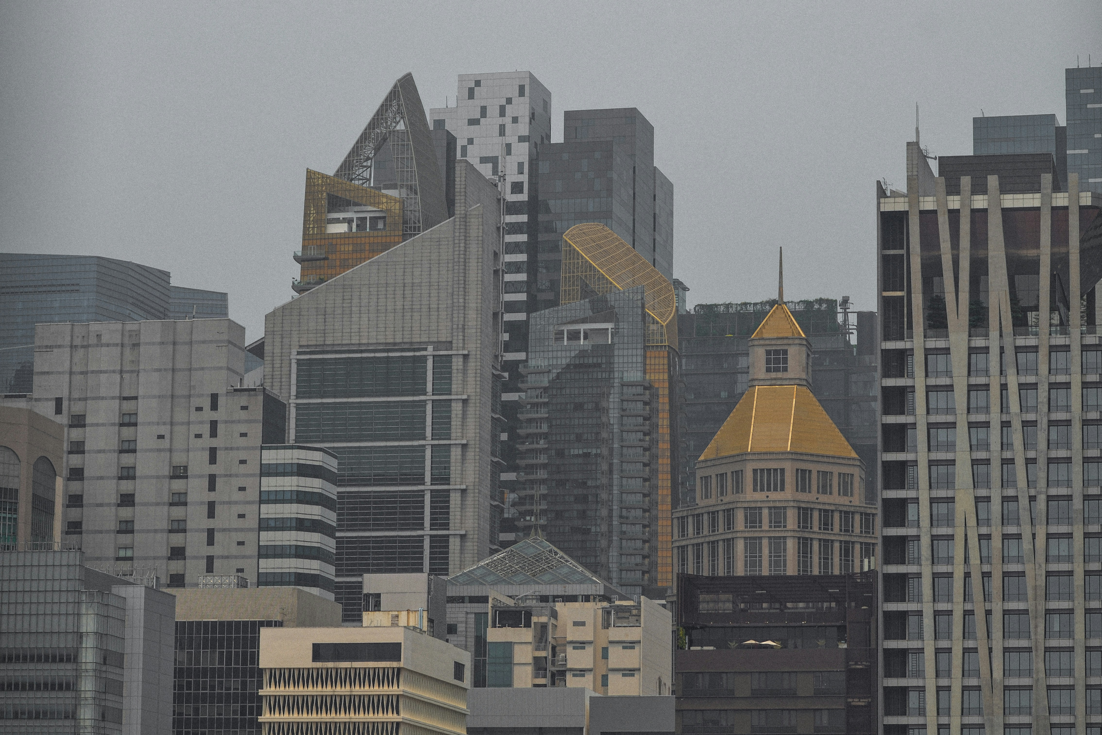 Gilded Peaks Rise Over a Sea of Glass and Steel