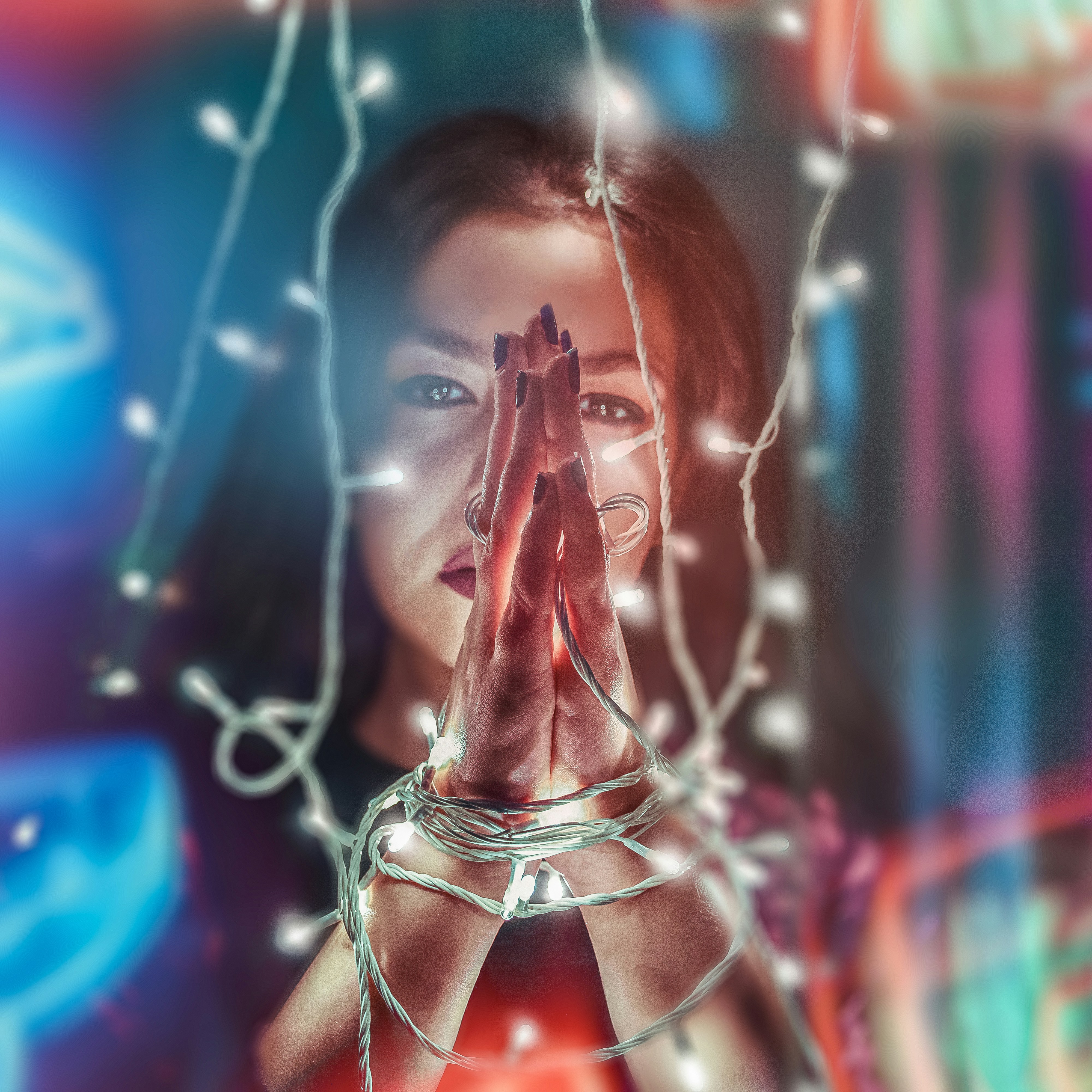 Neon Prayer: Portrait Shrouded in Fairy Lights