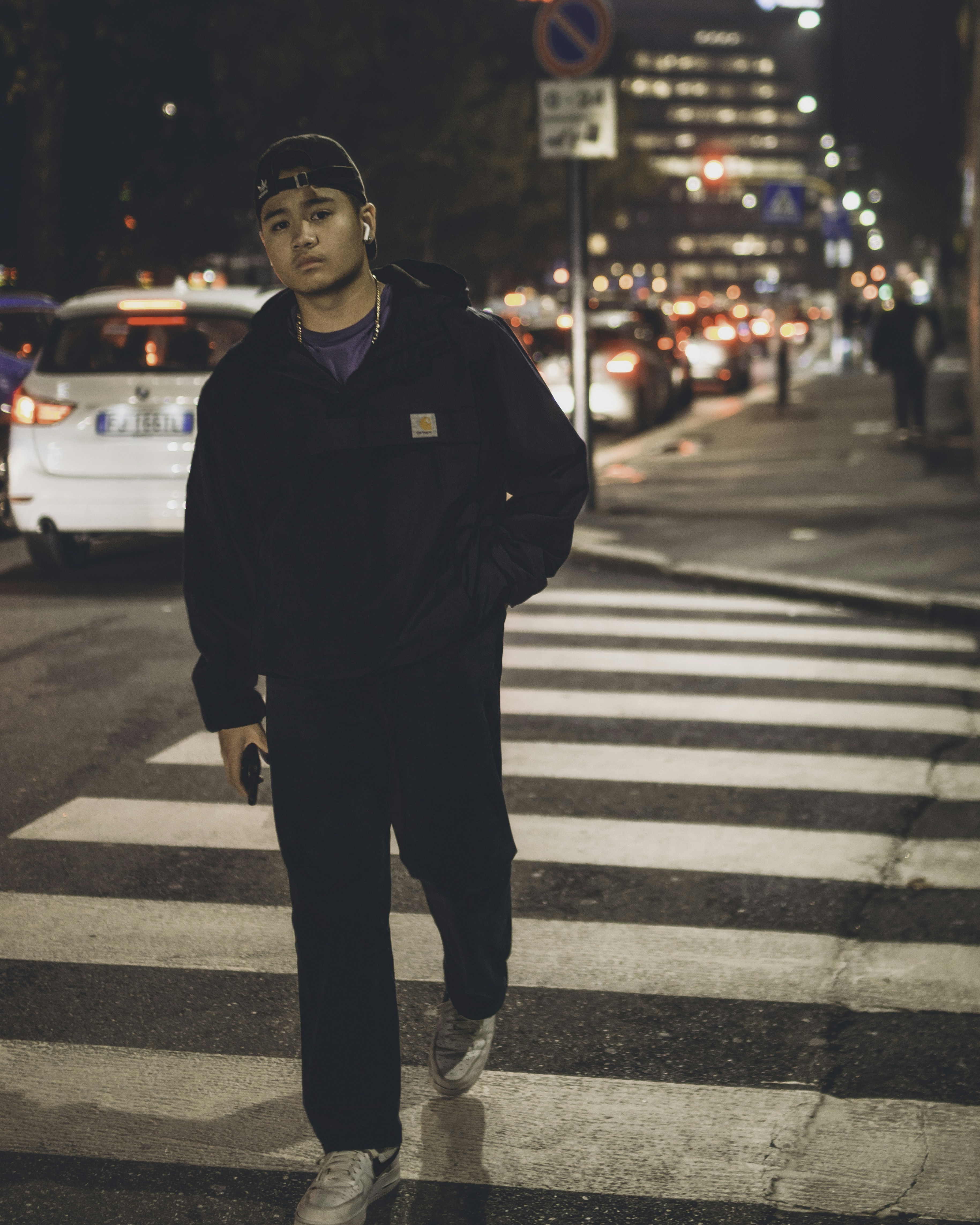 Midnight Crossing: A lone figure strides through a neon-doused crosswalk