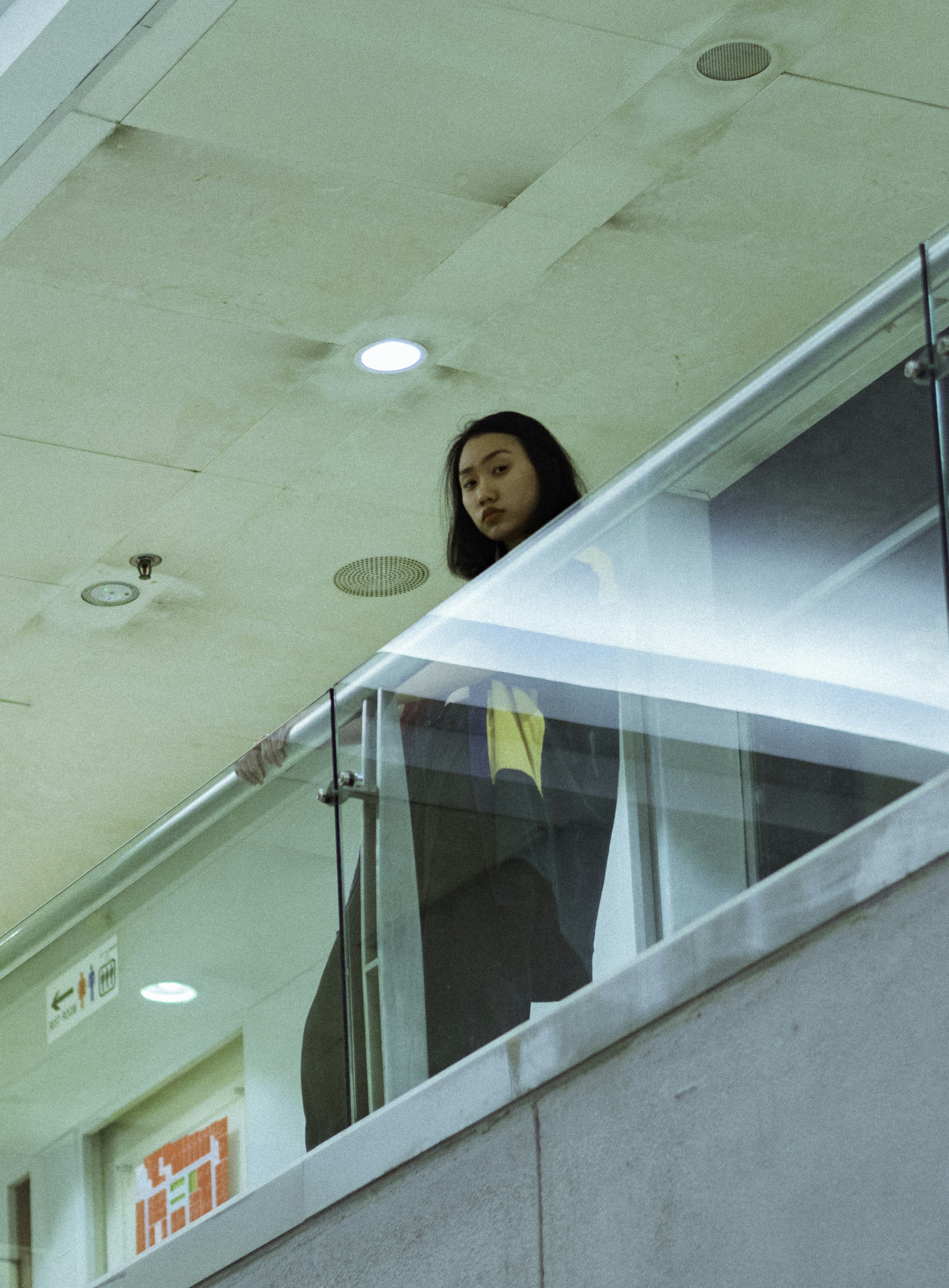 woman standing beside rail