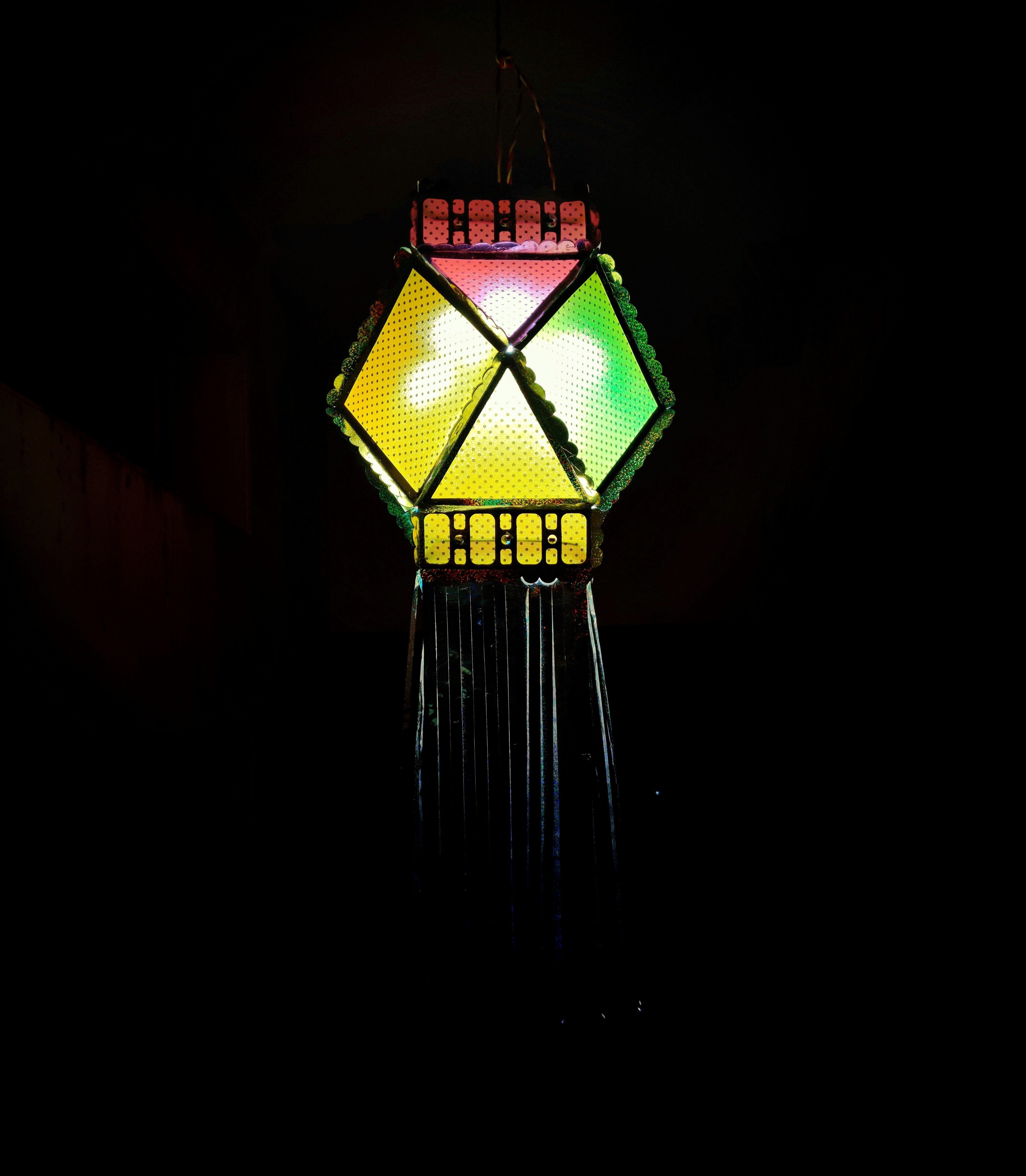Luminous Geometric Lantern Adrift in Night
