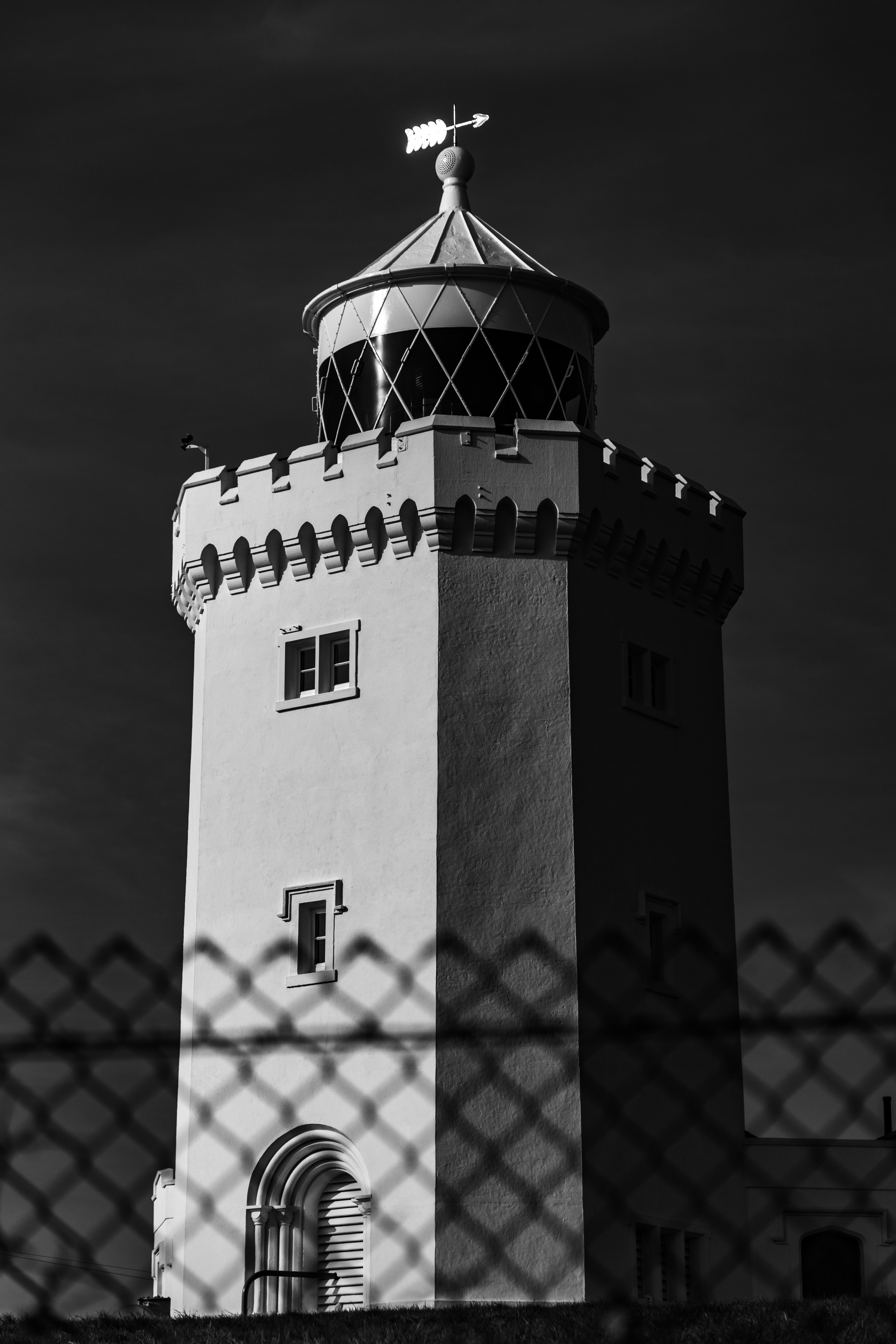 Watchtower in Focus: A Distant Fence and the Tower’s Shadow