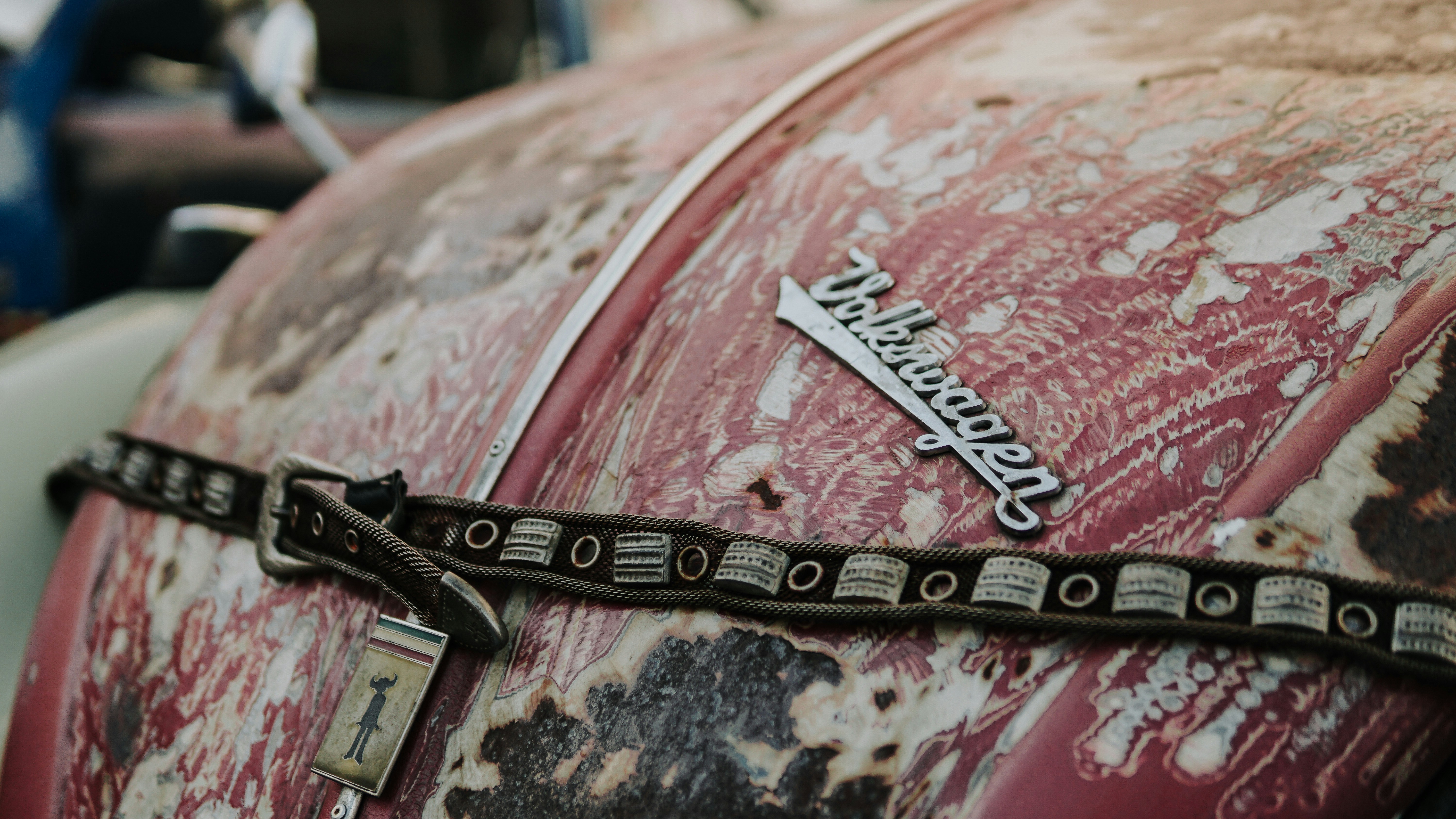 a close up of a rusted out car with a name tag on it
