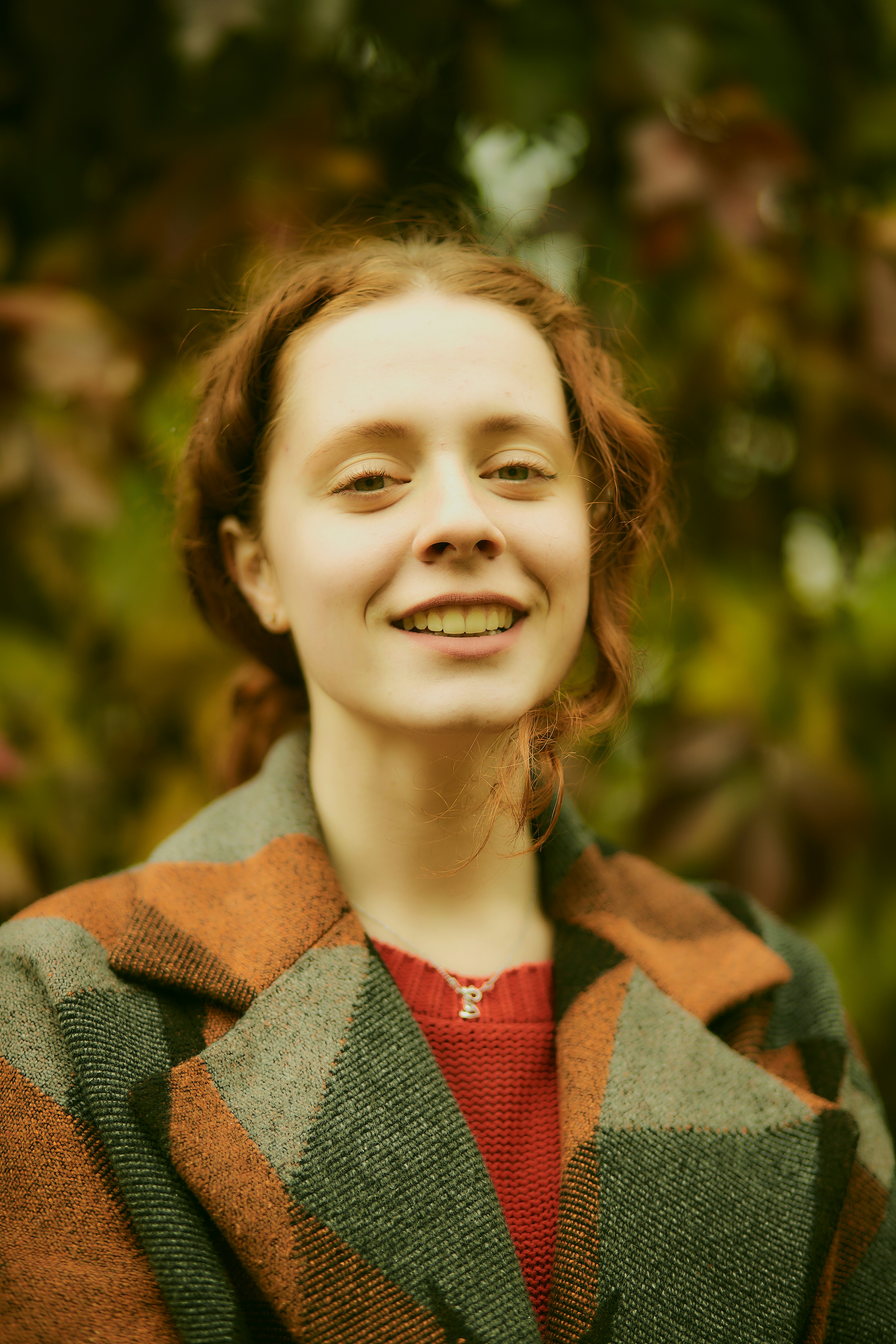 Autumnal Portrait: Warm Smile Amid Dense Foliage