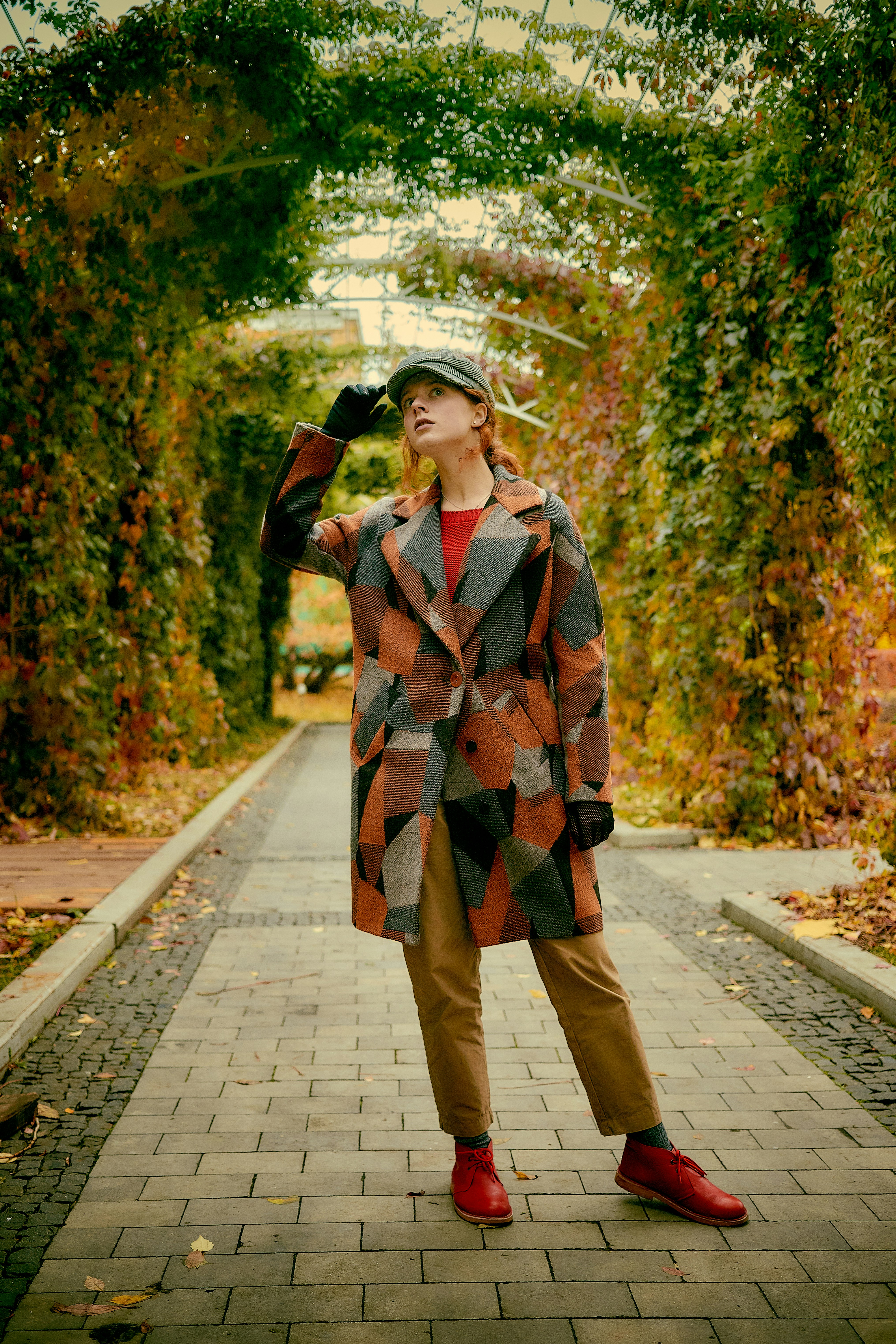 Geometric Autumn: A Bold Coat Stands Under the Garden Arch