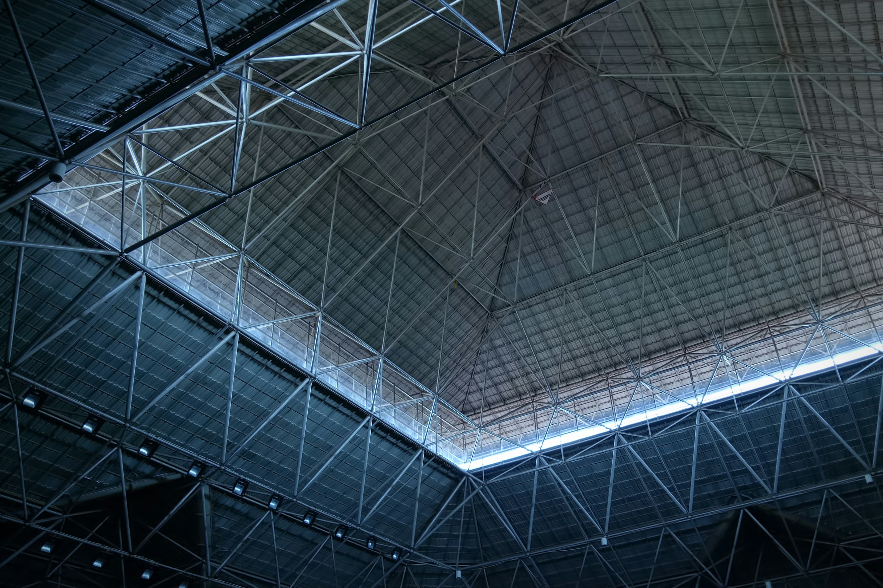 The ceiling of a stadium with a clock on it photo – Free Grey Image on ...